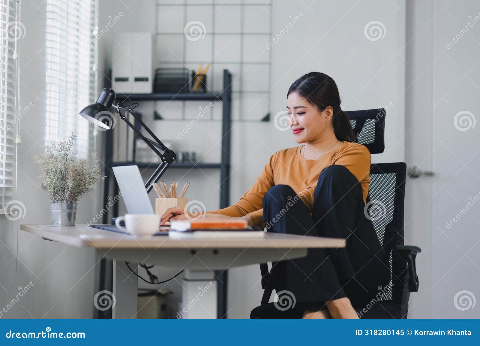 Contented Woman Working on Laptop in a Home Office Setup. Stock Image ...