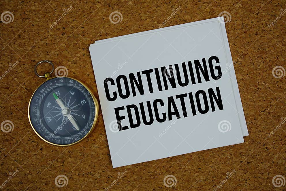 Continuing Education Text on Paper Card with Compass on Cork Paper ...