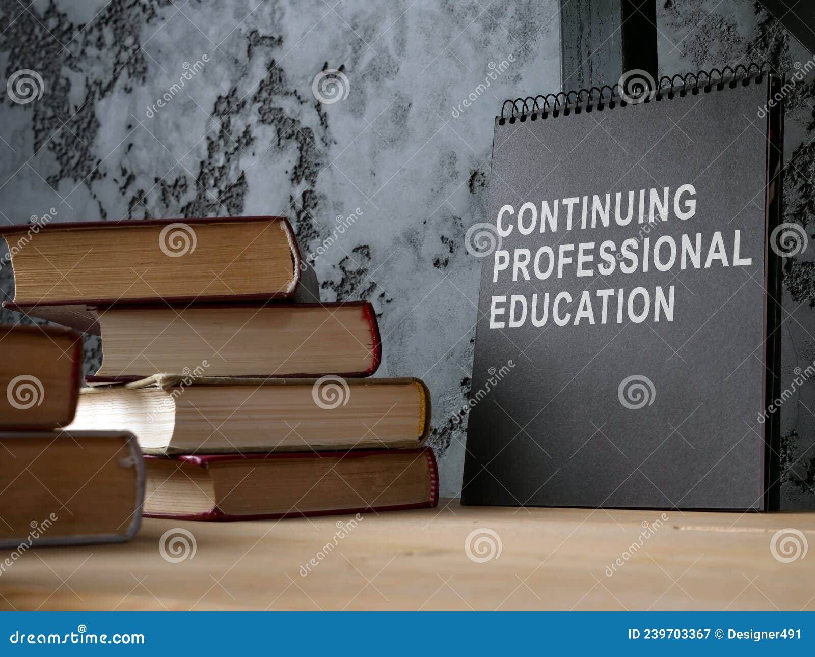 Continuing Professional Education on the Black Notepad and Books. Stock ...