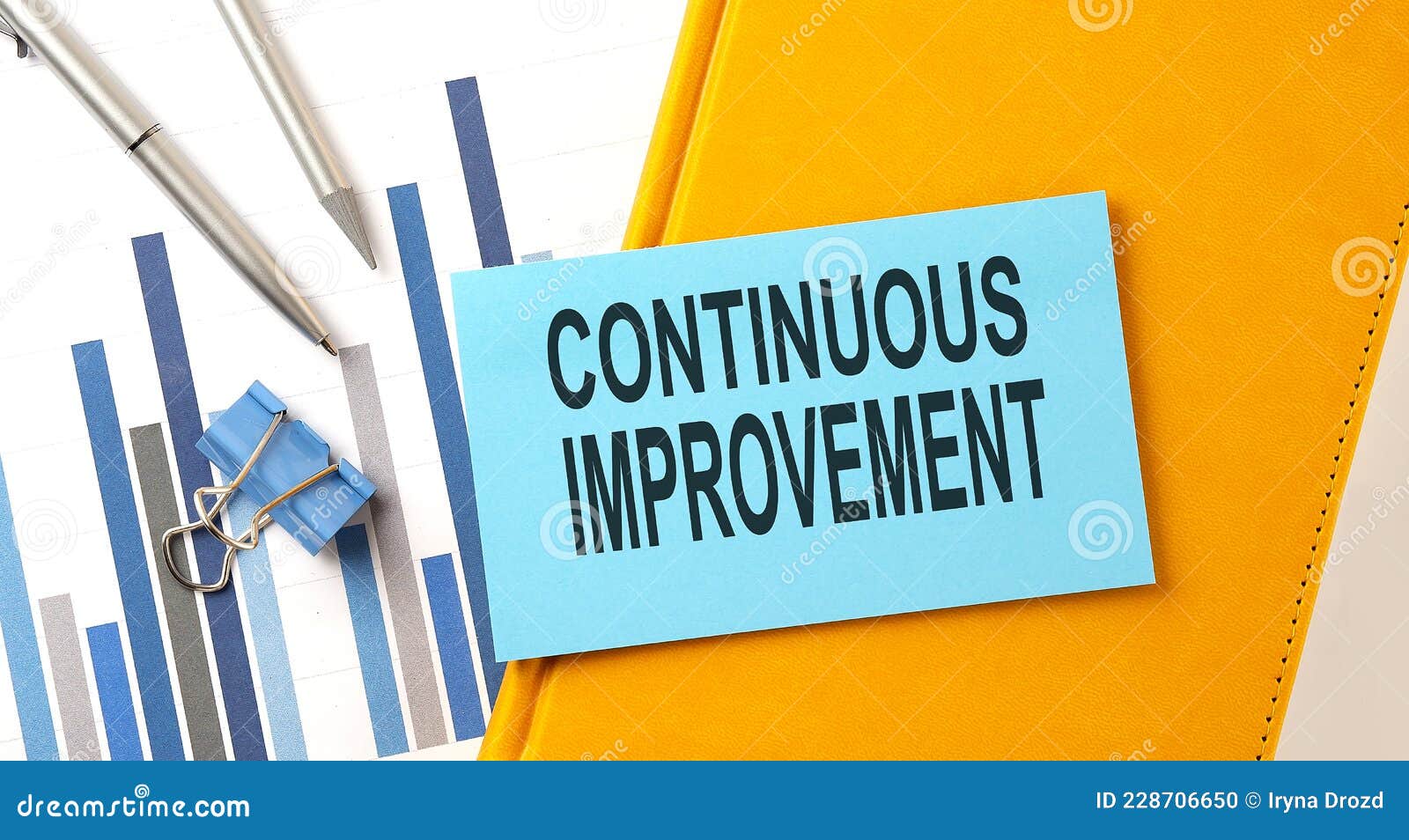 Continuous Improvement Text on Sticker on the Yellow Notebook with ...