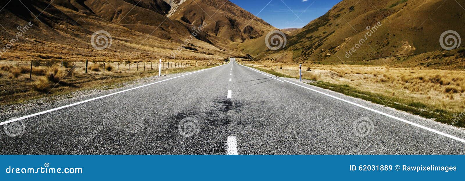Continuous Road In A Scenic With Mountain Ranges Afar Stock Image ...