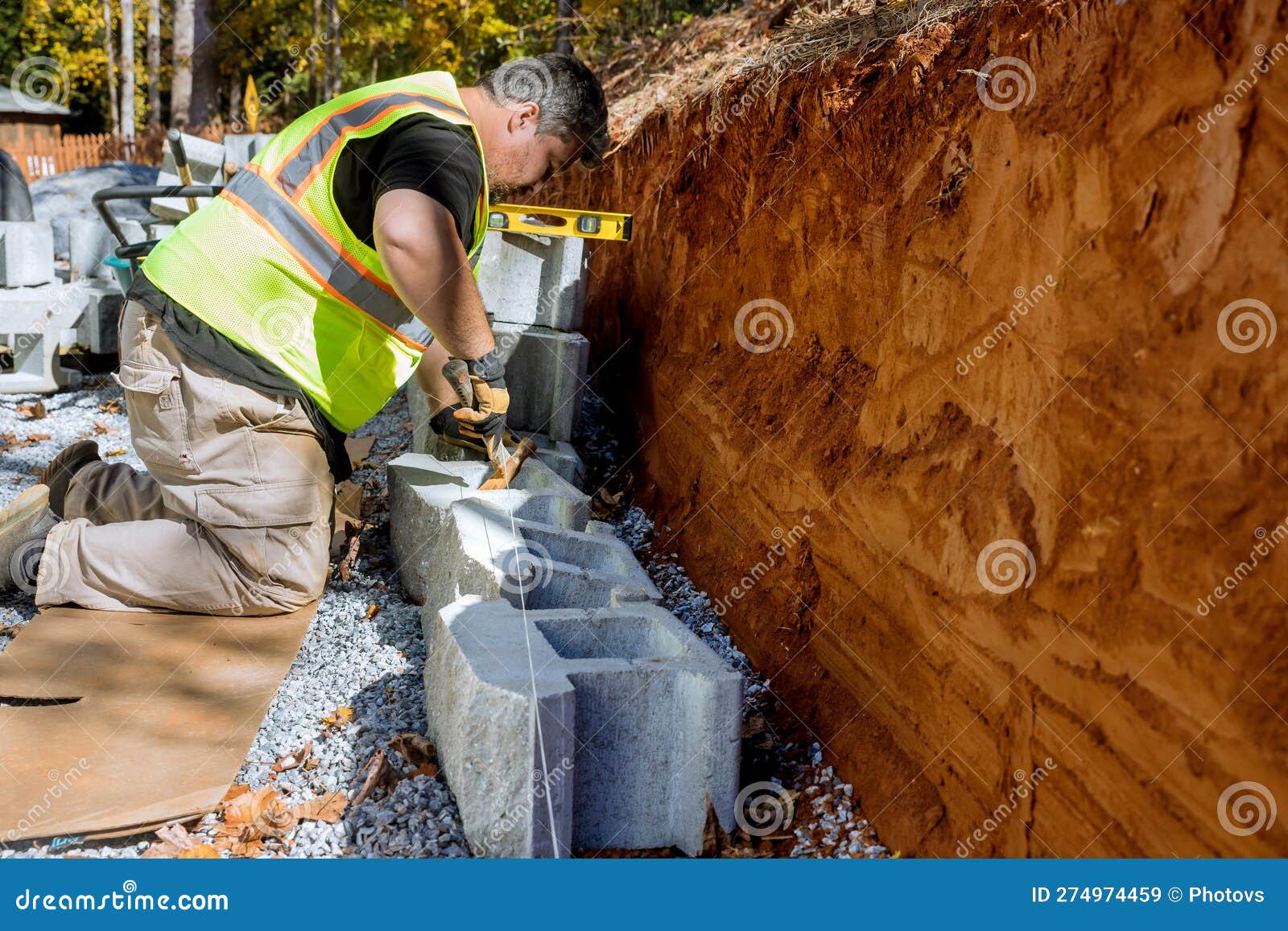 A Contractor is Constructing a Block Retaining Wall on a Construction ...