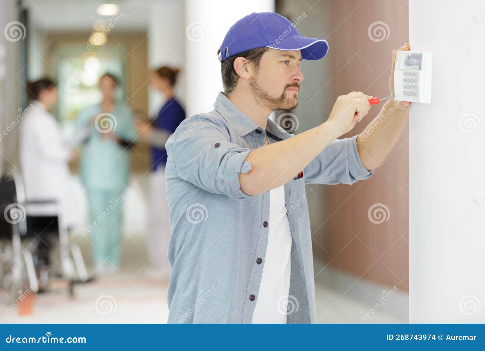 Contractor Fixing Keypad To Wall in Hospital Stock Photo - Image of ...