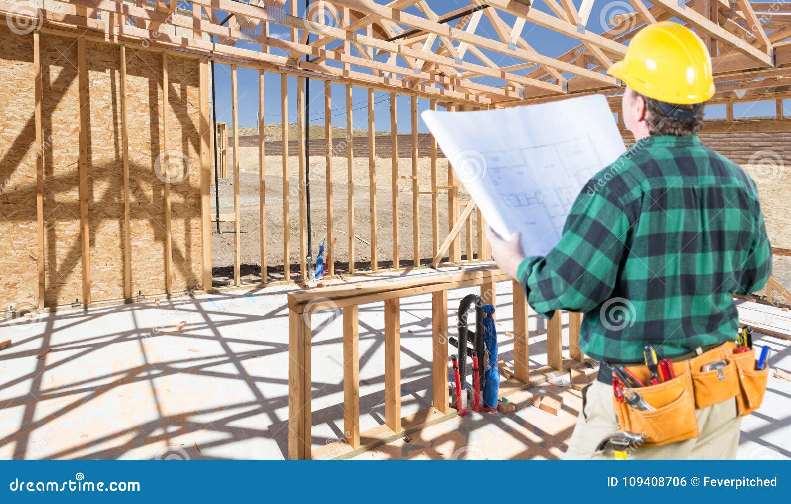Contractor with Hard Hat and Plans Standing in Construction Site Stock ...