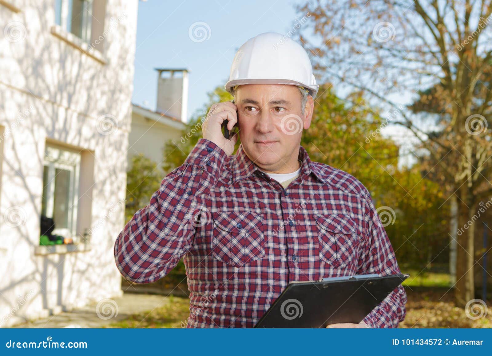 Contractor Holding Cost Information and Calling Stock Photo - Image of ...