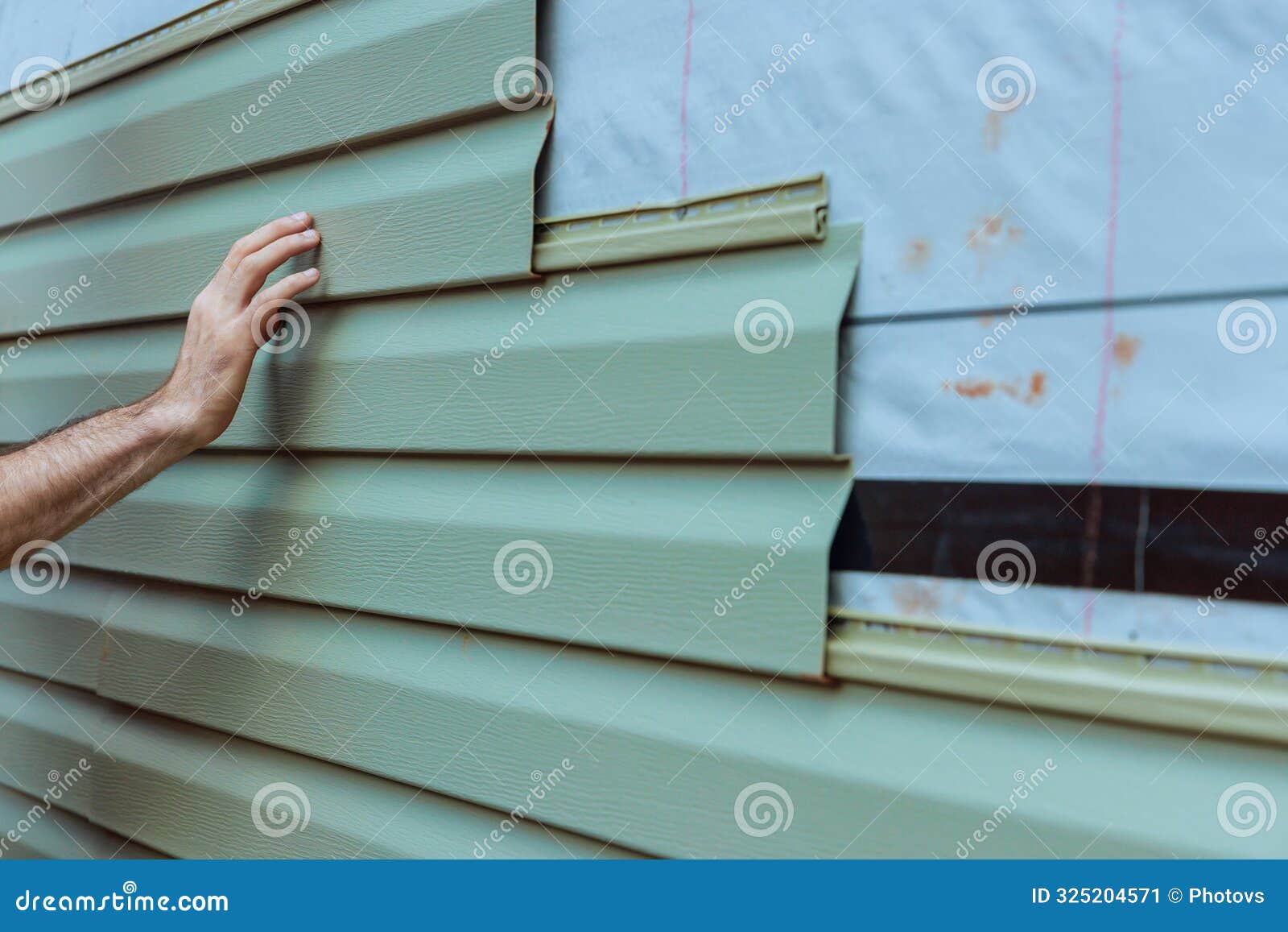 Contractor Installing Vinyl Siding Plastic Panels on Facade Wall of a ...