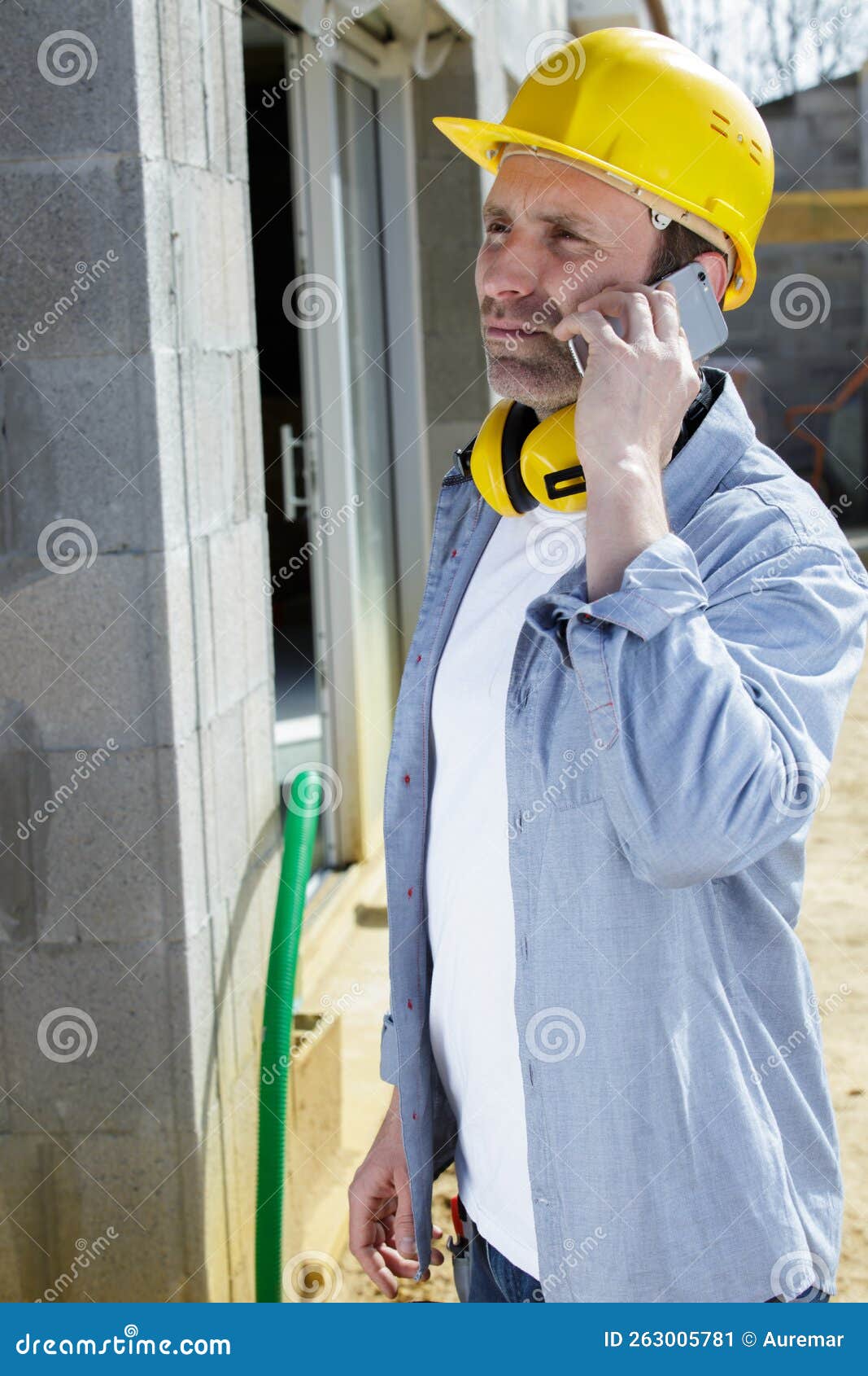 Contractor with Mobile Phone and Yellow Hard Hat Outdoors Stock Image ...