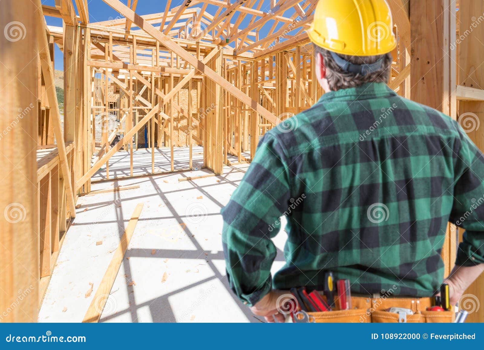 Contractor Standing Inside Construction Framing of New House. Stock ...