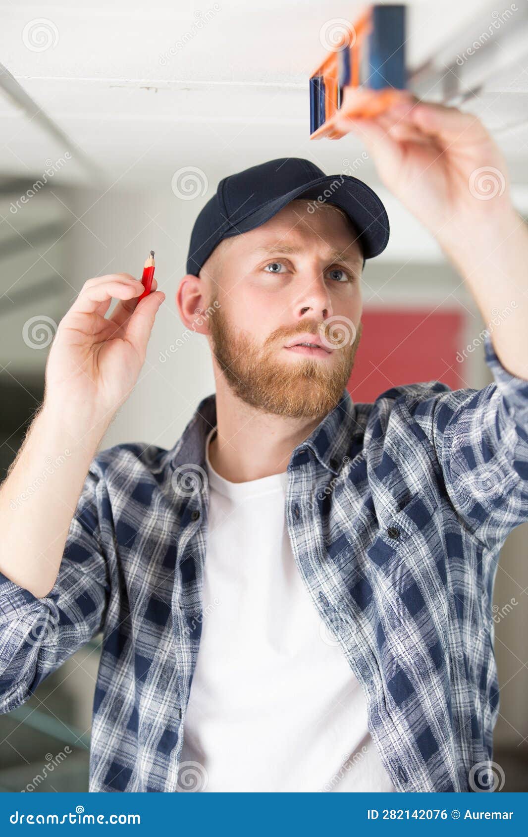 Contractor Taking Ceiling Measures with Spirit Level Stock Photo ...