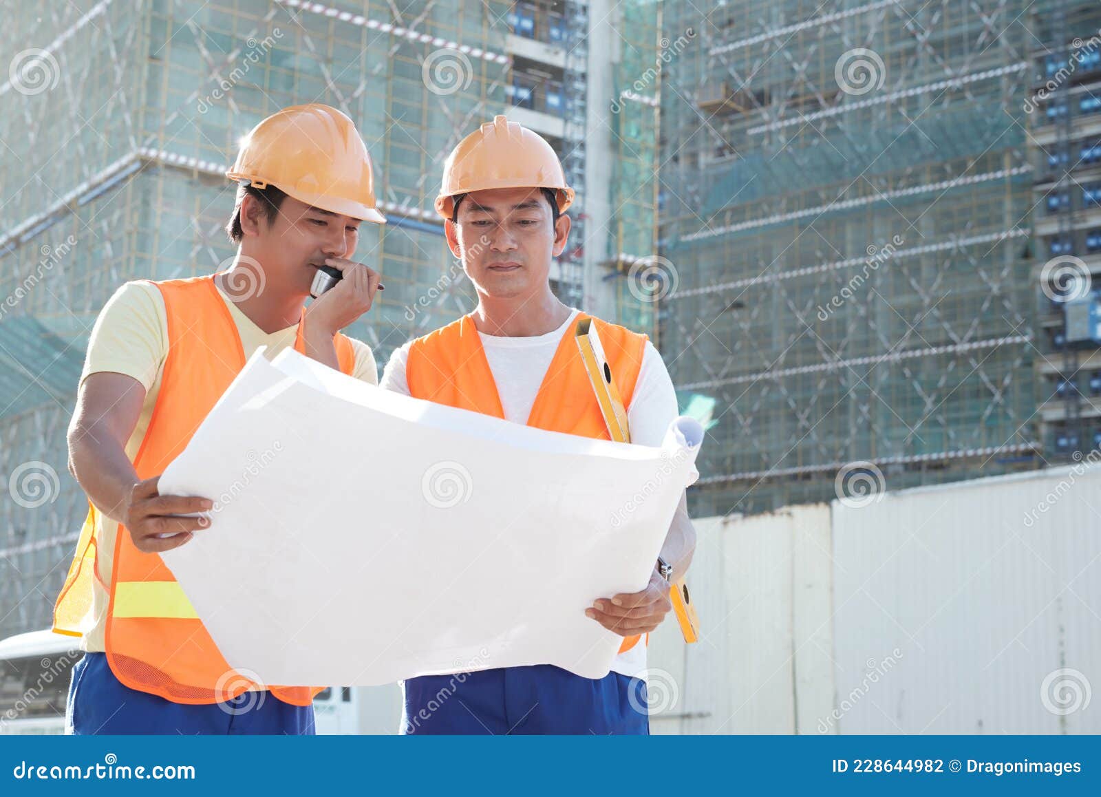 Contractor Talking with Builders Via Walkie-talkie Stock Photo - Image ...