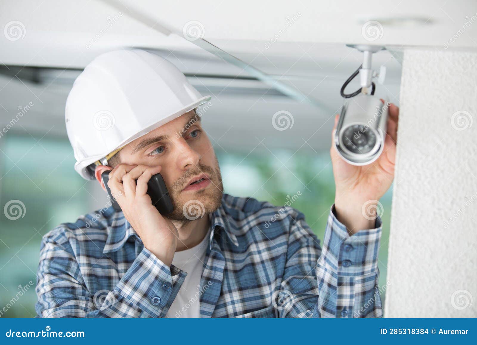 Contractor Talking on Telephone by Cctv Camera Stock Photo - Image of ...