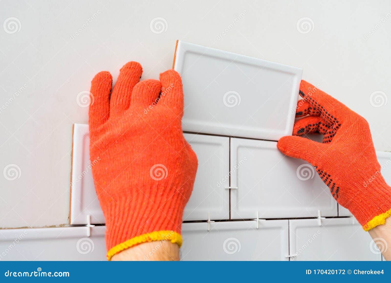 Contractor is Tiling the White Tiles on the Kitchen Wall. Concept of a ...