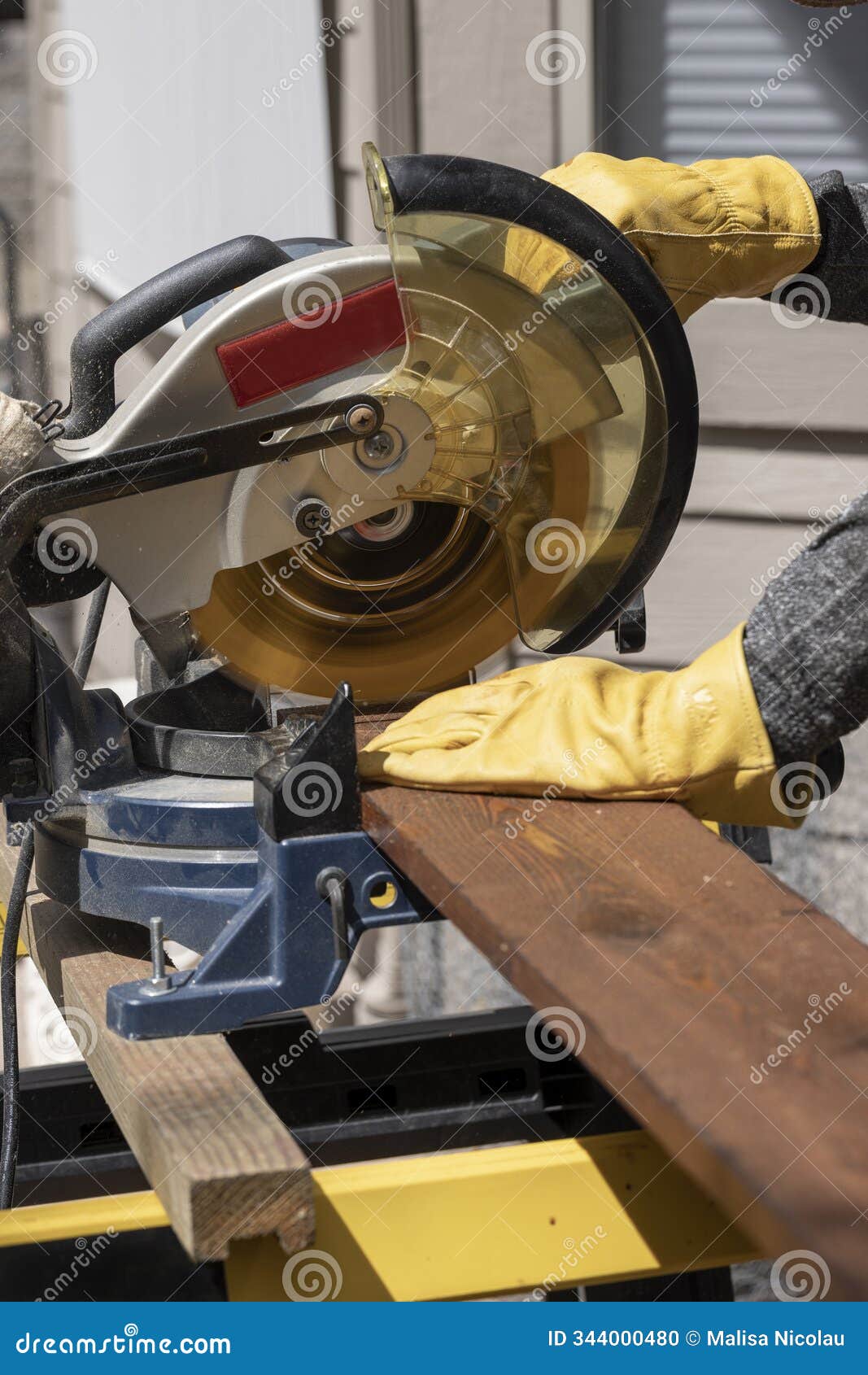 Contractor Using a Table Saw To Construct a Wood Screen in a Home Yard ...