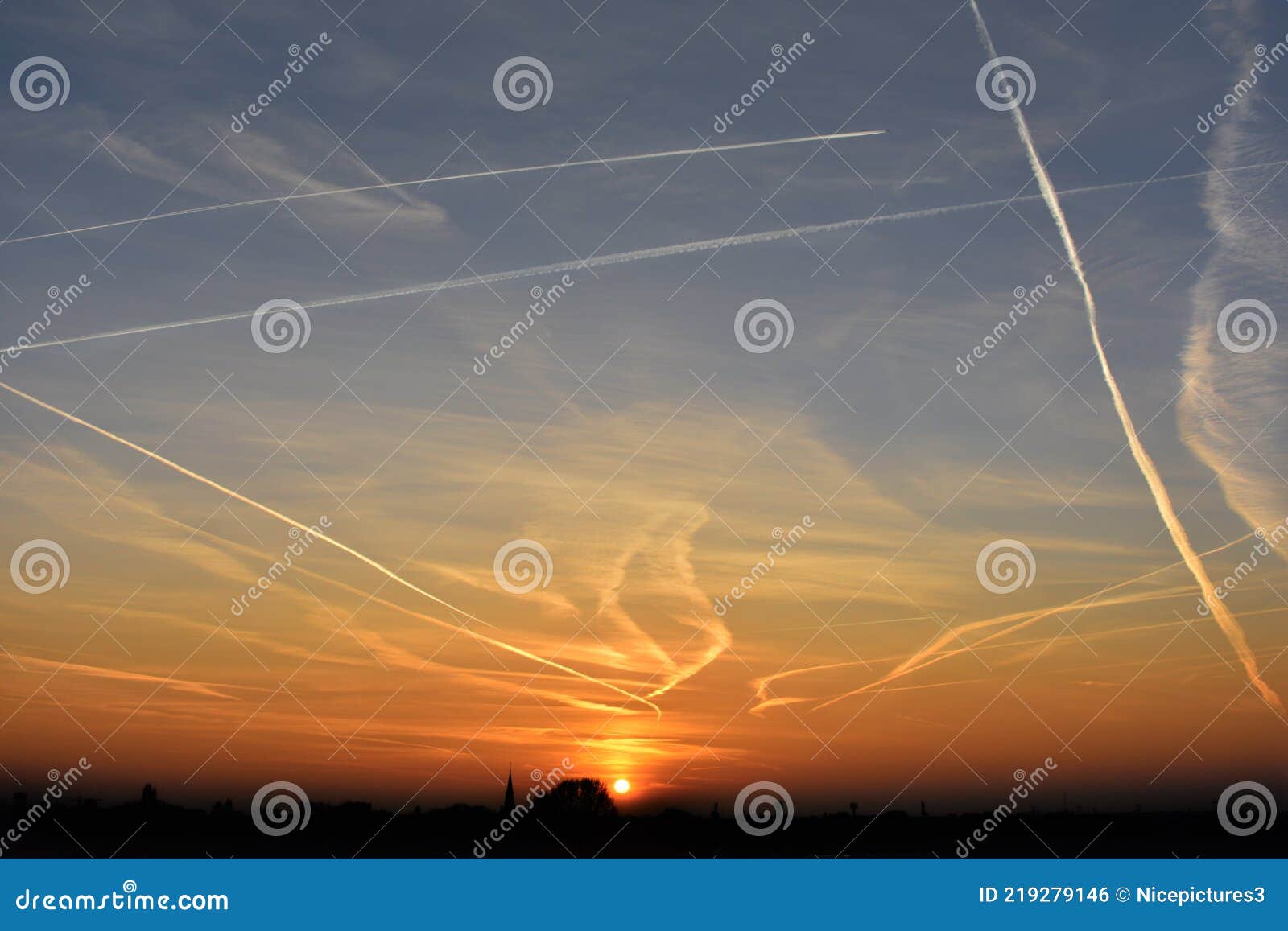 Contrails in the Sky at Sunset Stock Photo - Image of sunset, chemtrail ...