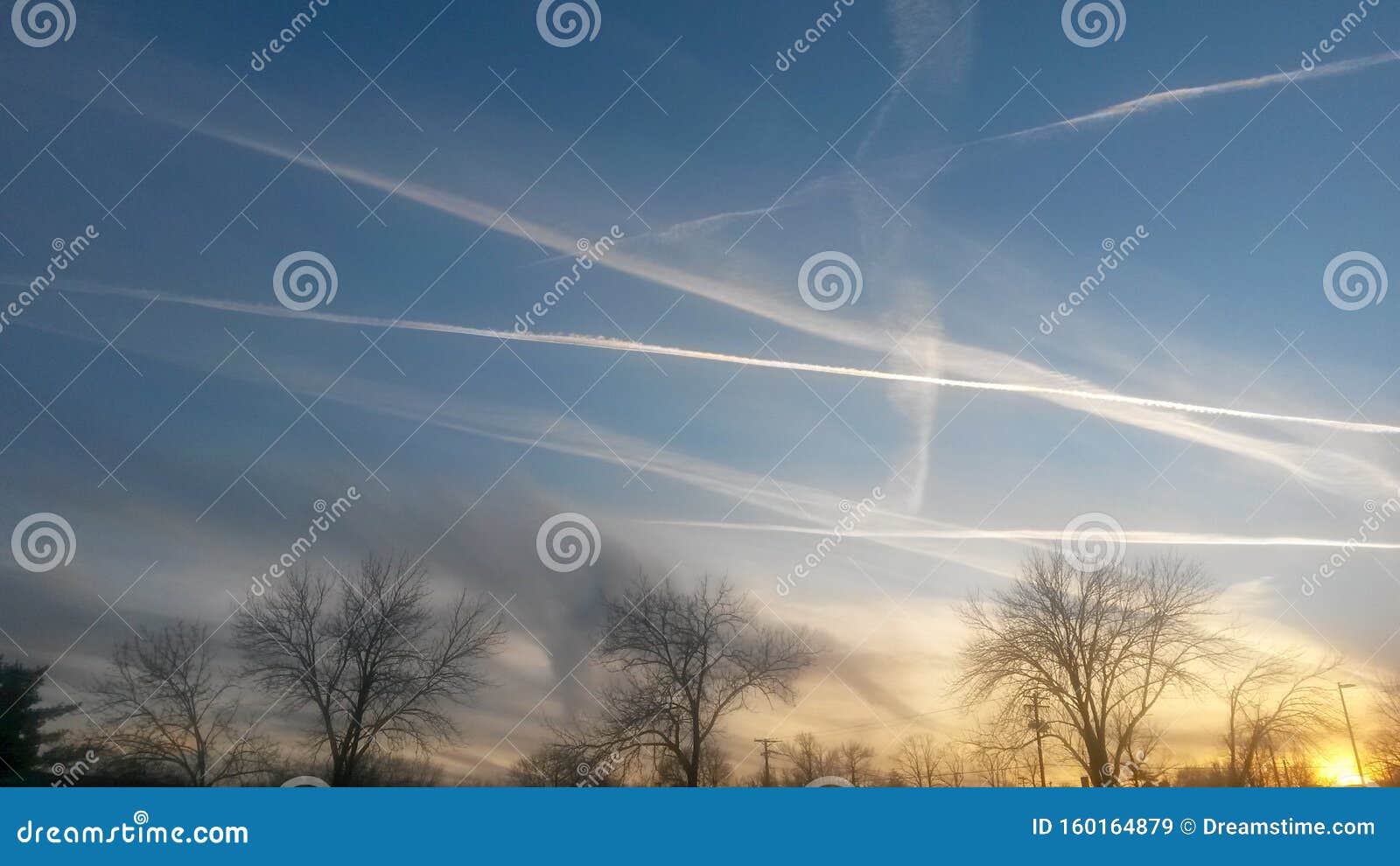Contrails at sunset stock image. Image of patterns, wispy - 160164879