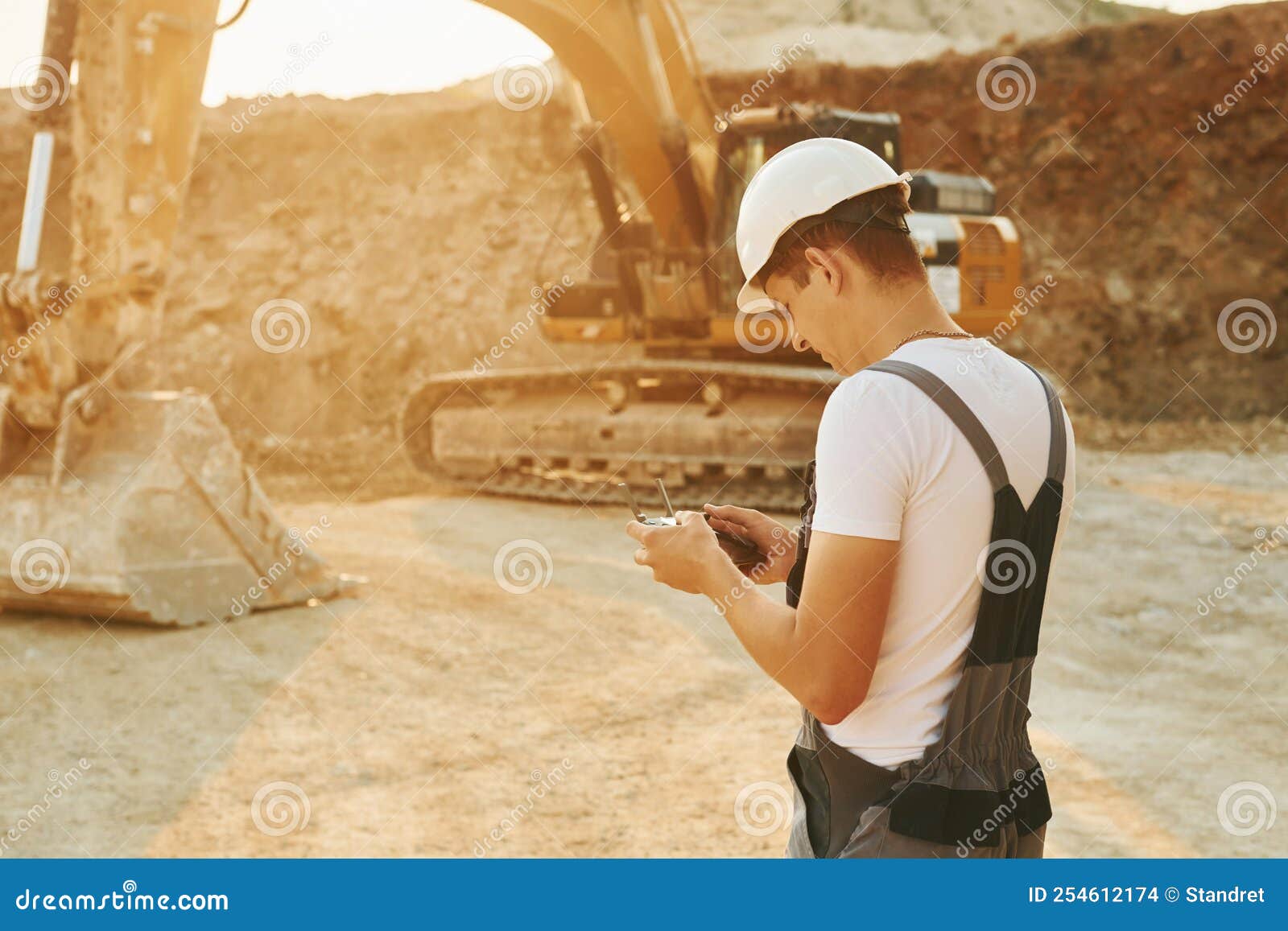 Control of the Project. Worker in Professional Uniform is on the Borrow ...
