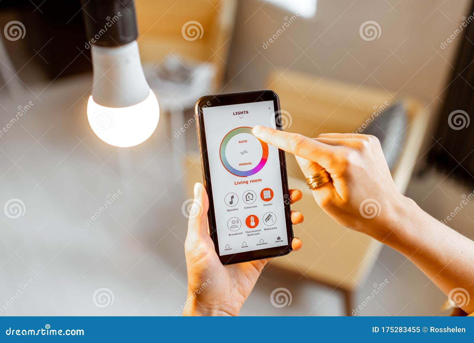 Controlling Light Bulb with Mobile Device Stock Image - Image of ...