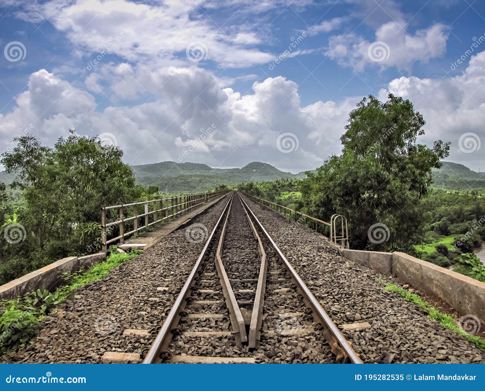 Converging Rail Track Over Bridge with Nice Blue Sky and Clouds ...
