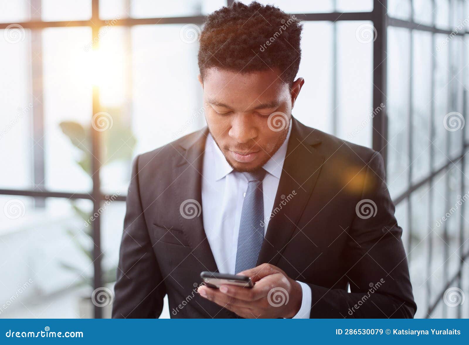 This Conversation is Interesting. Young Guy Using Smartphone Stock ...