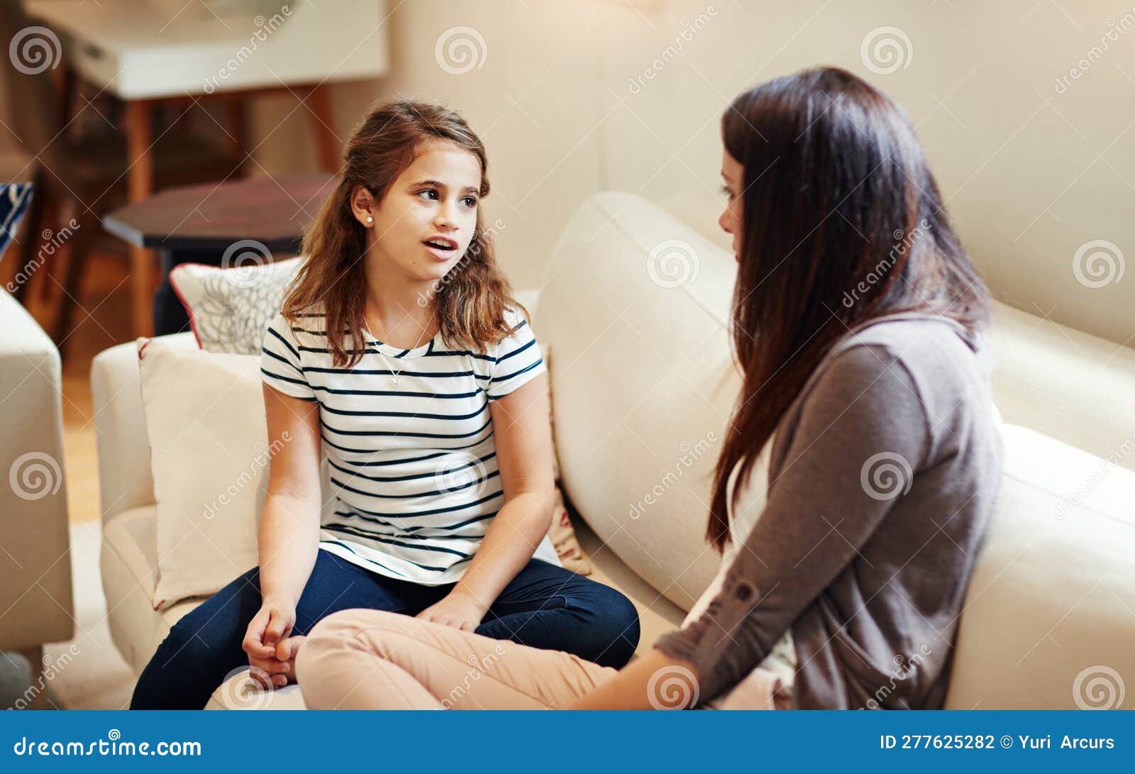 Conversation Mother With Daughter Talking On Sofa And Living Room In