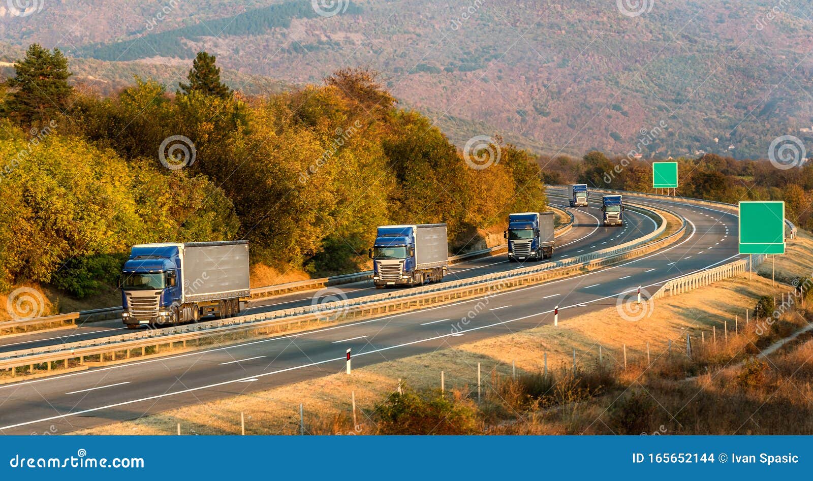 Convoy of Blue Lorry Trucks on a Highway Stock Photo - Image of ...