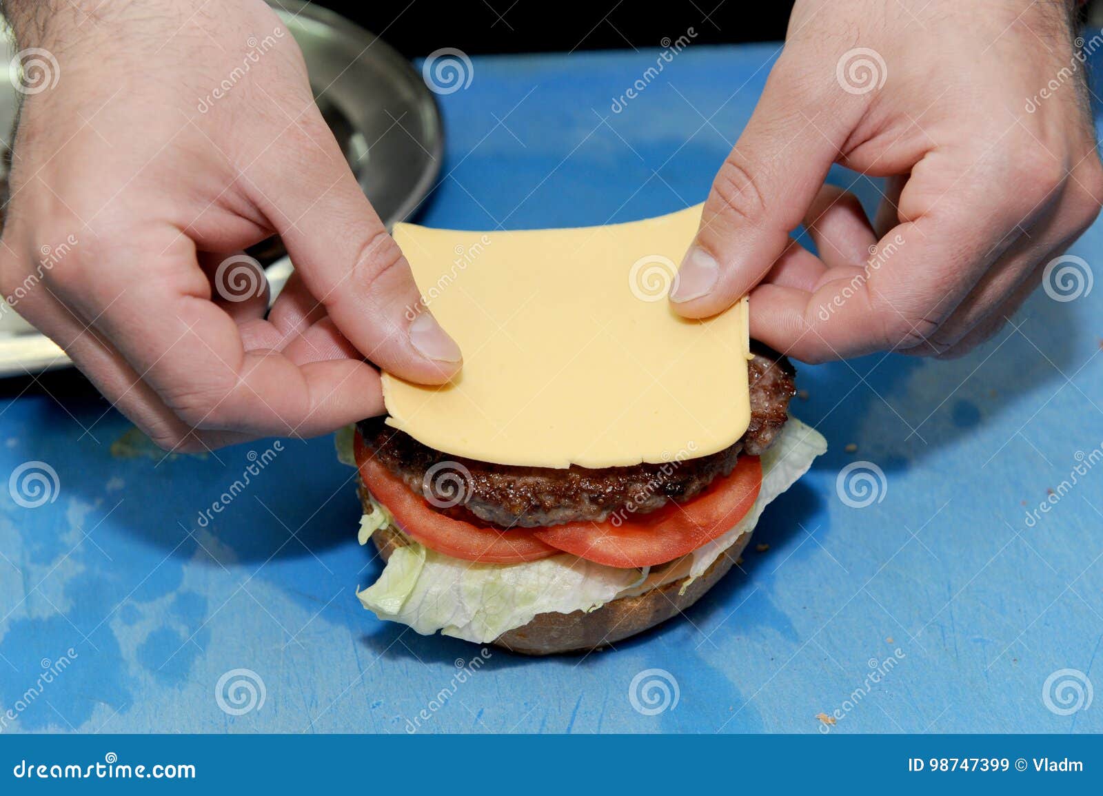 Cook Adding Cheese on Burger. Preparing and Making Hamburger. Stock ...