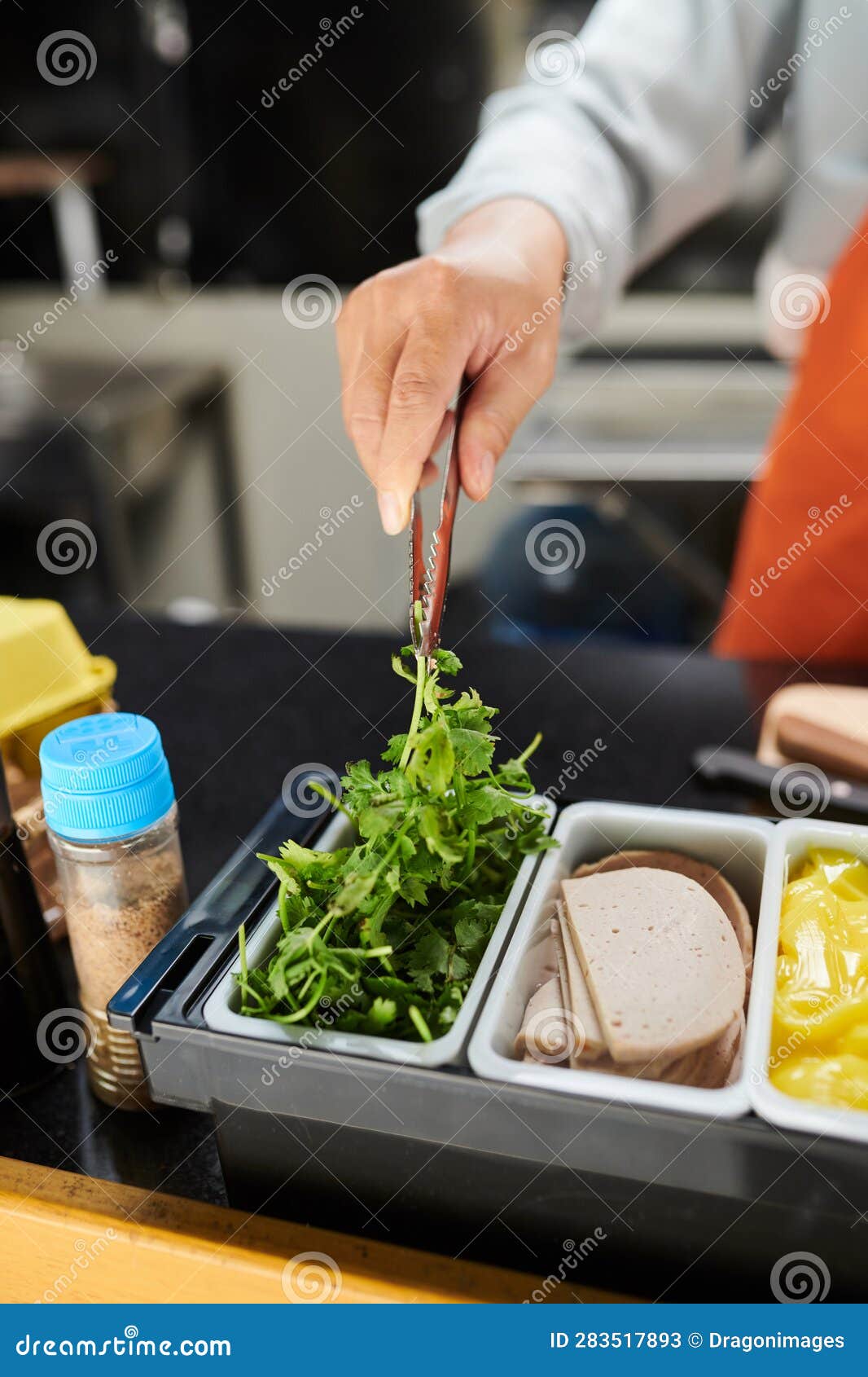 Cook Adding Cilantro in Sandwich Stock Image - Image of bread, tongs ...
