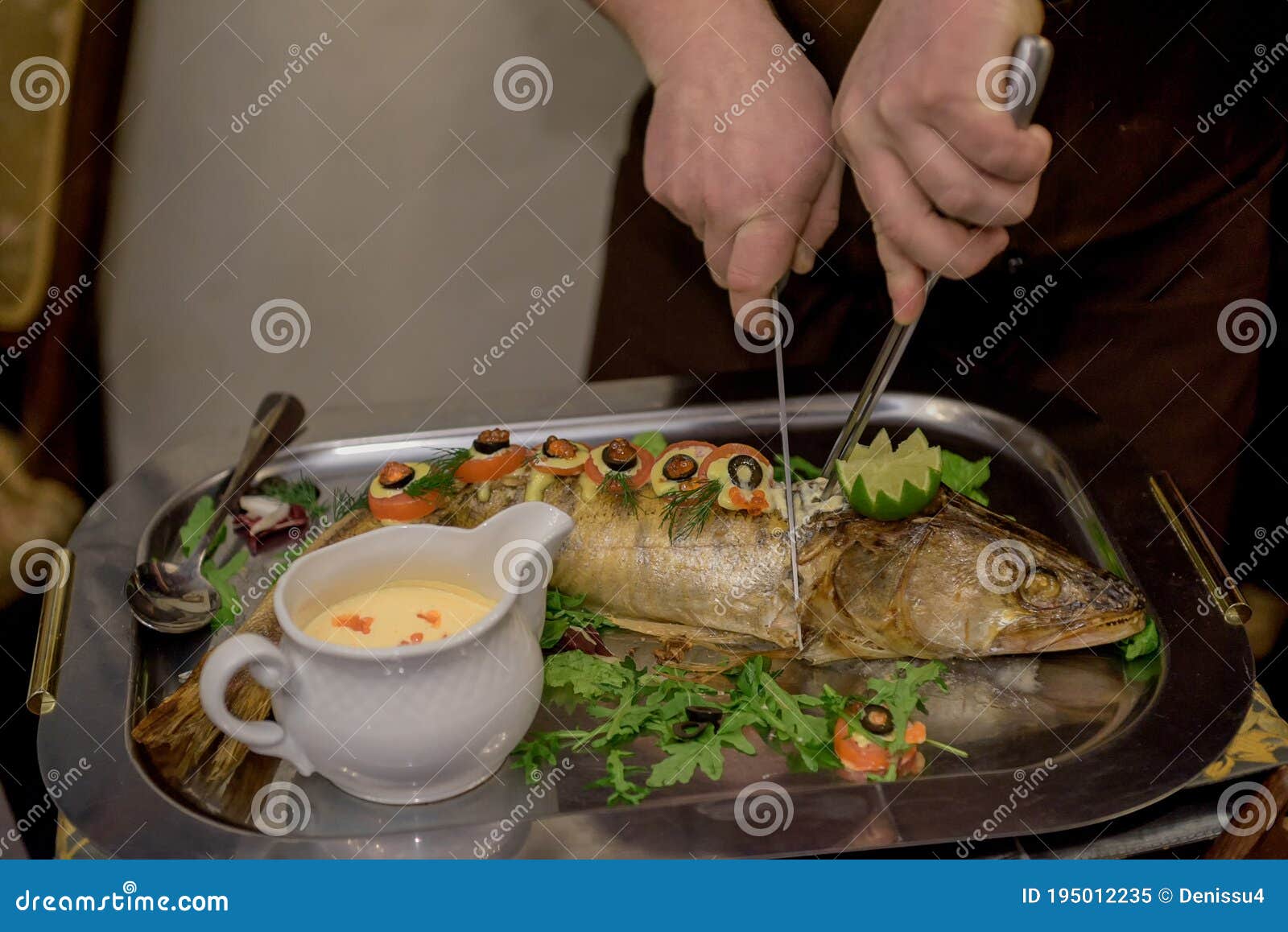 Cook Cuts Fried Fish with Vegetables and Herbs with Knife Stock Image ...