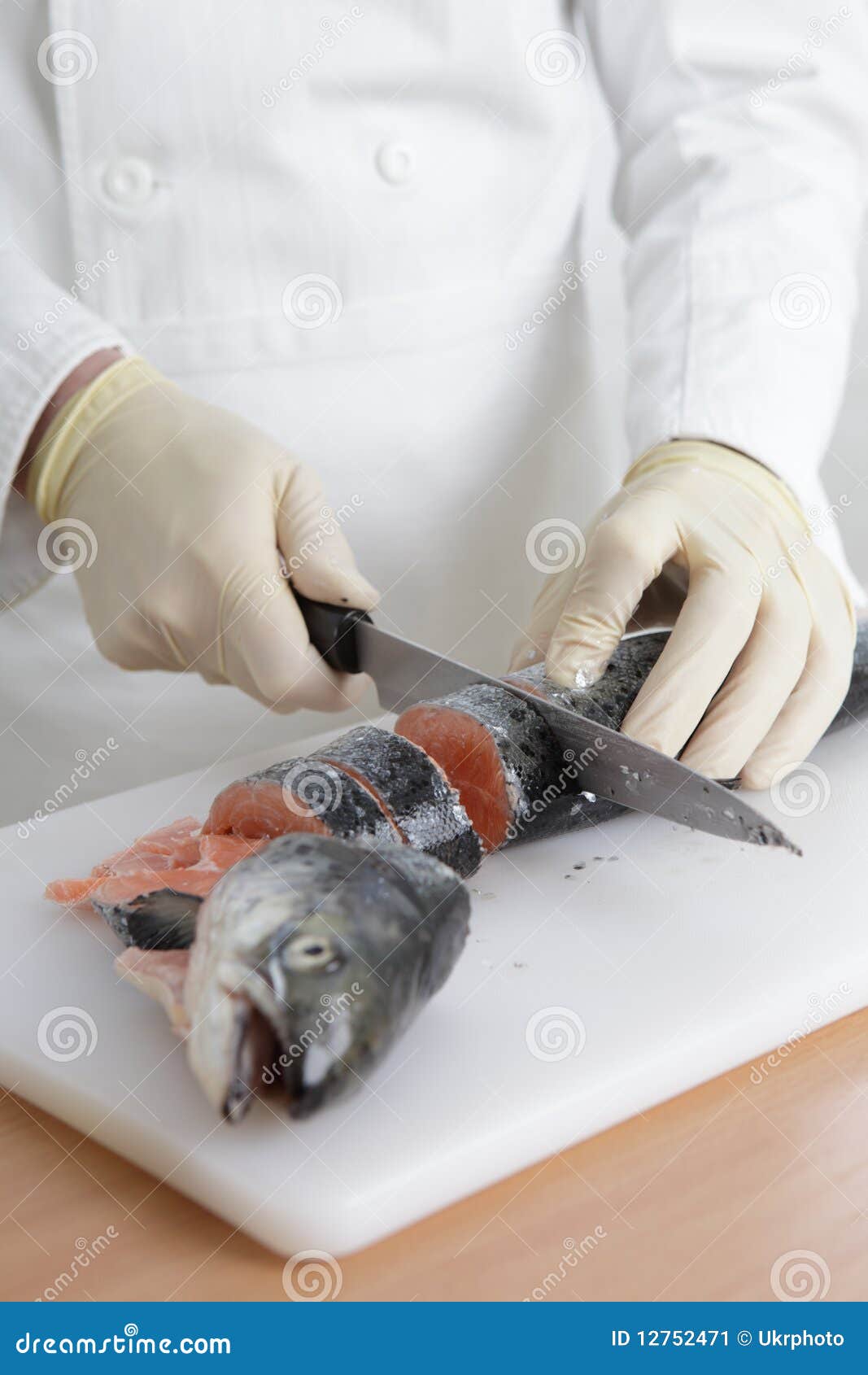 Cook cutting a fish stock image. Image of protective - 12752471