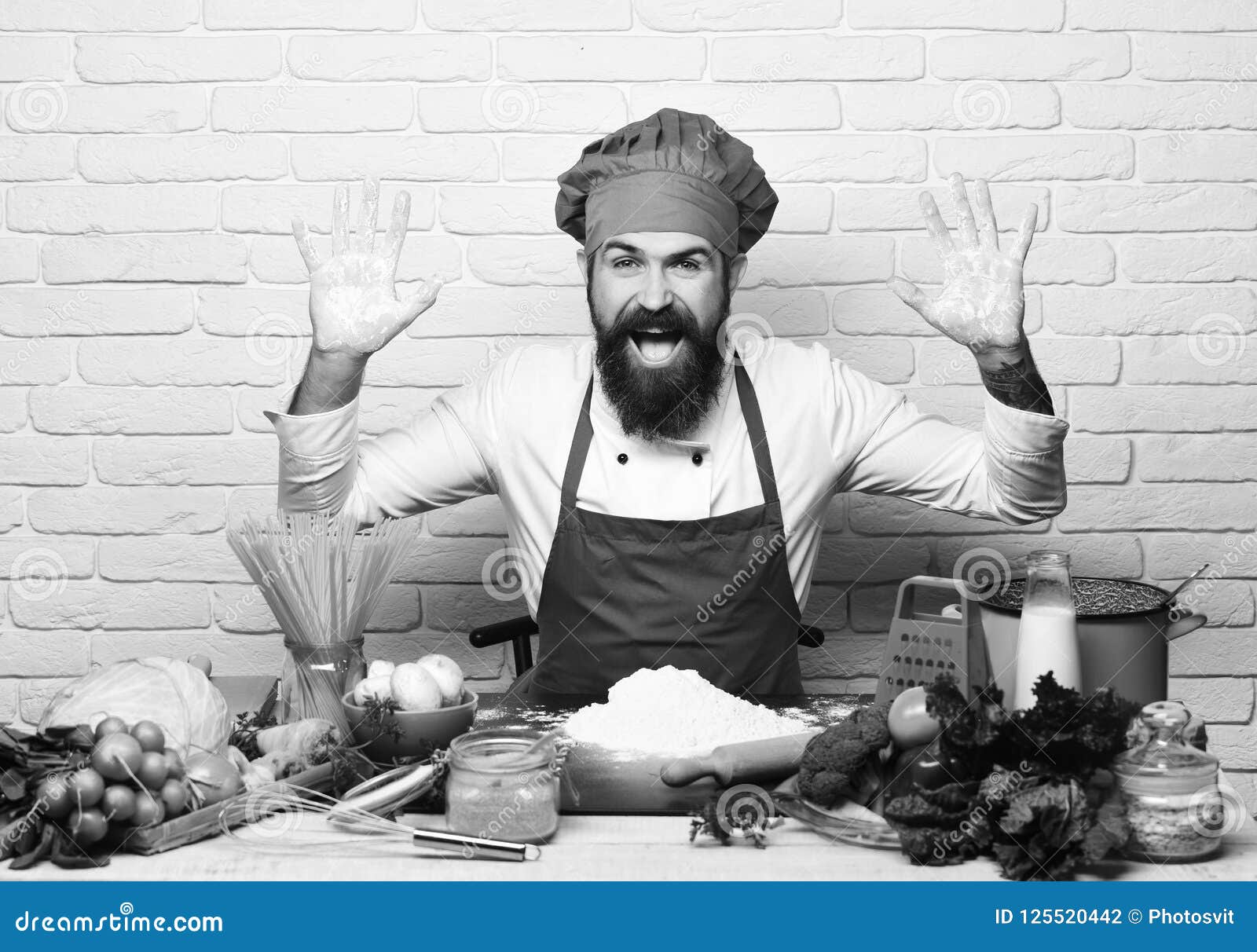Cook with Excited Face in Uniform Sits by Kitchen Table Stock Photo ...