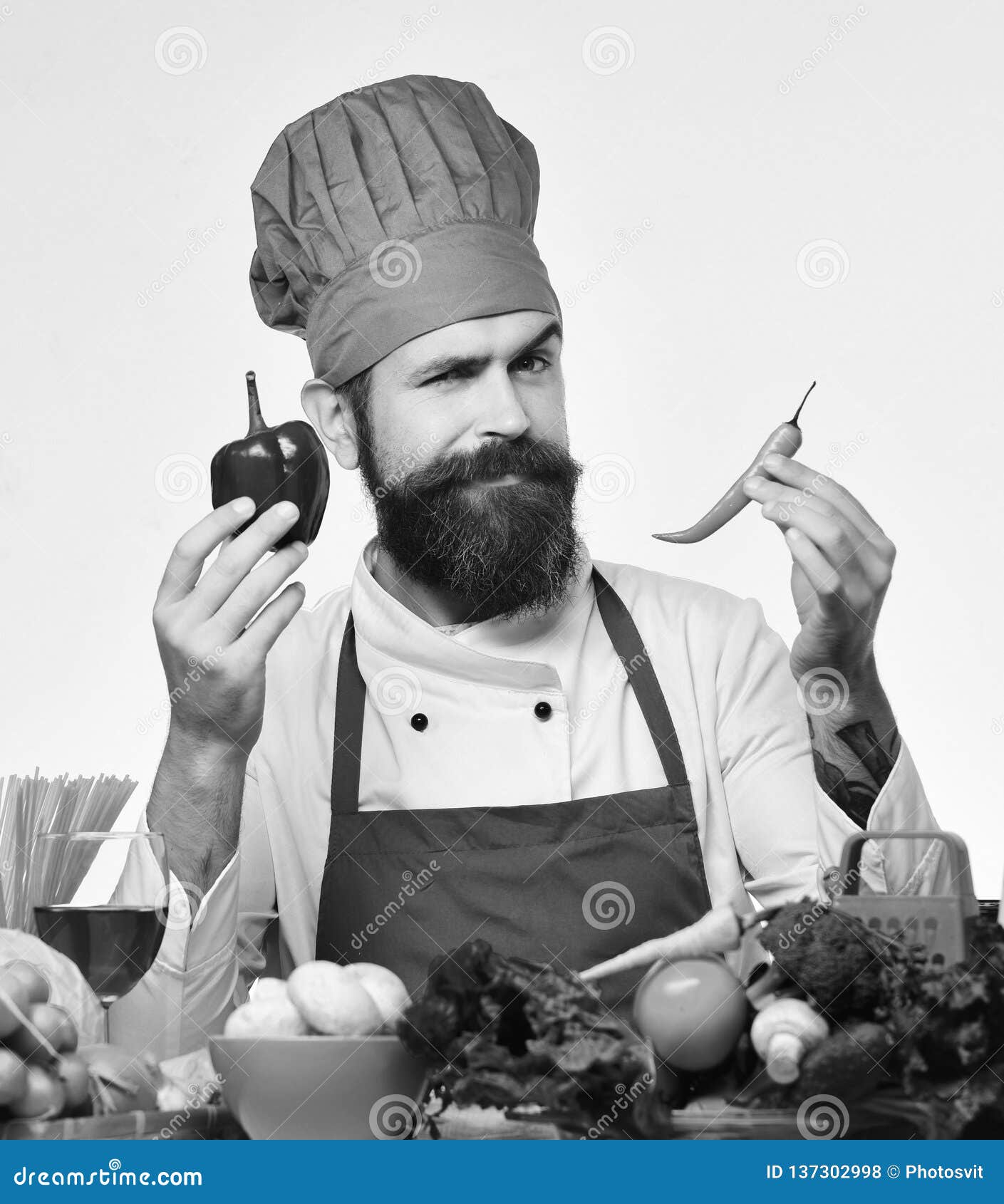Cook with Flirty Face in Uniform Sits by Kitchen Table Stock Photo ...