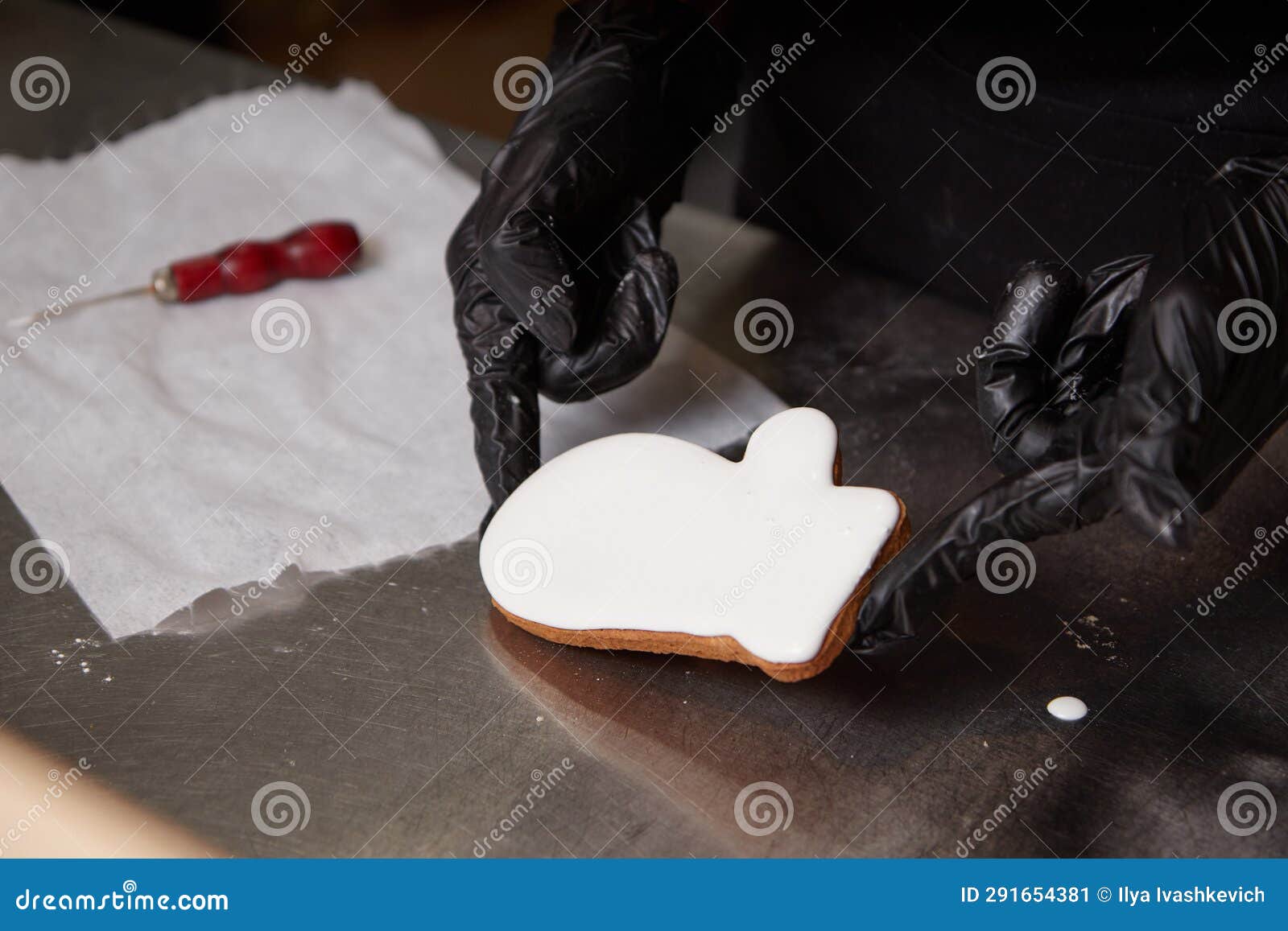 The Cook Holds a Ready Made Cookie Covered with White Icing with His ...