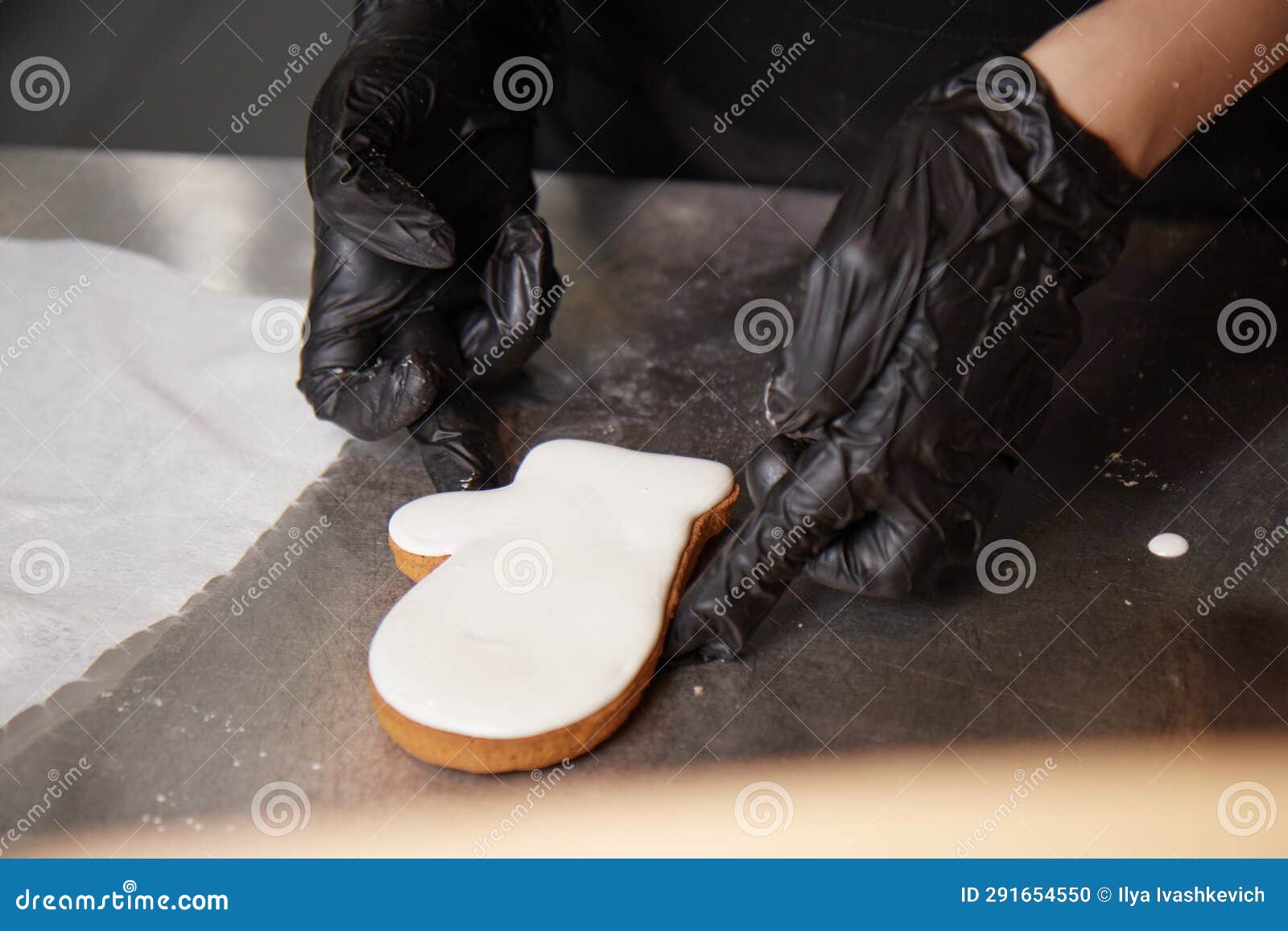 The Cook Holds a Ready Made Cookie Covered with White Icing with His ...