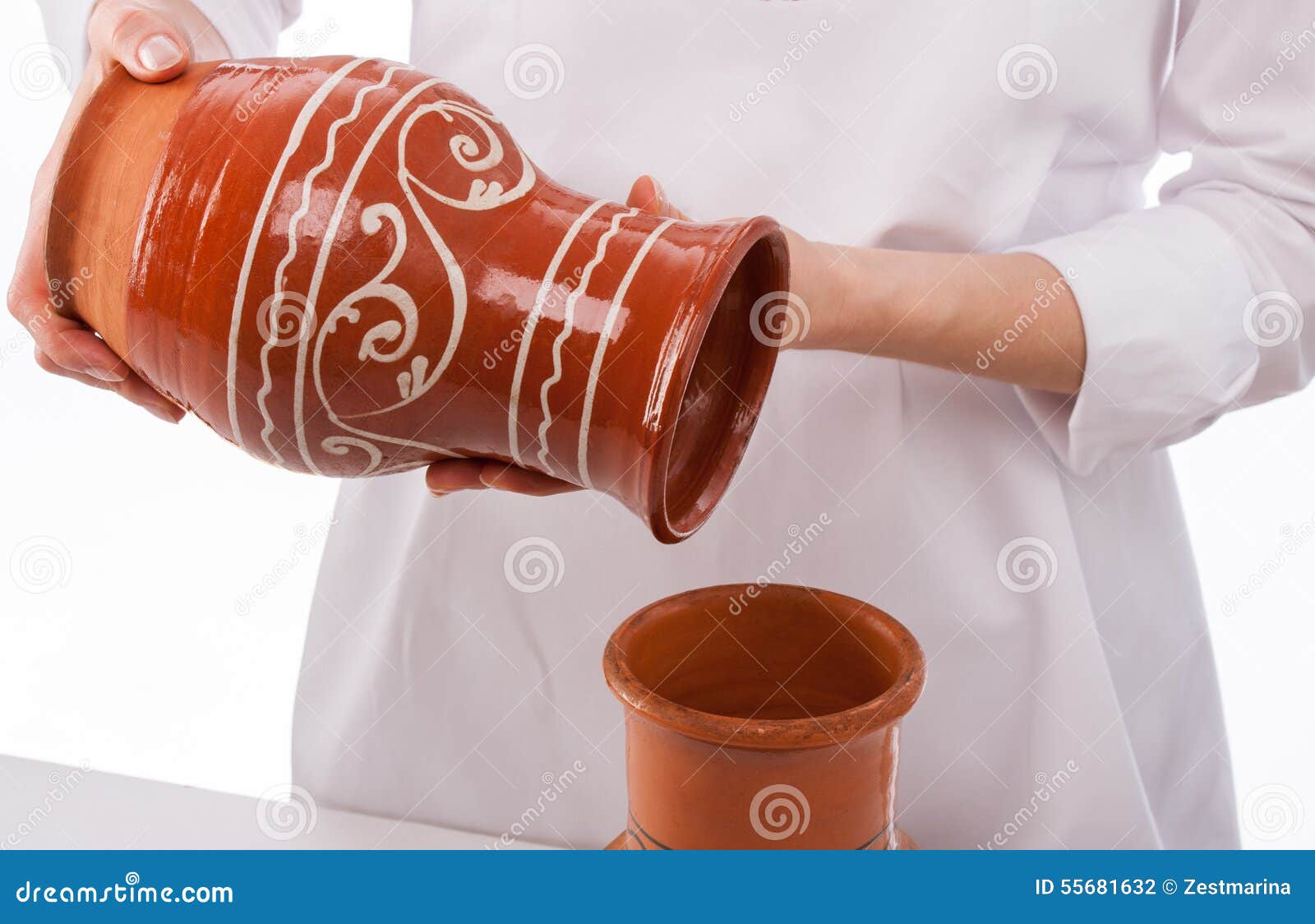 Cook Pouring Something into Clay Jug Stock Photo - Image of action ...