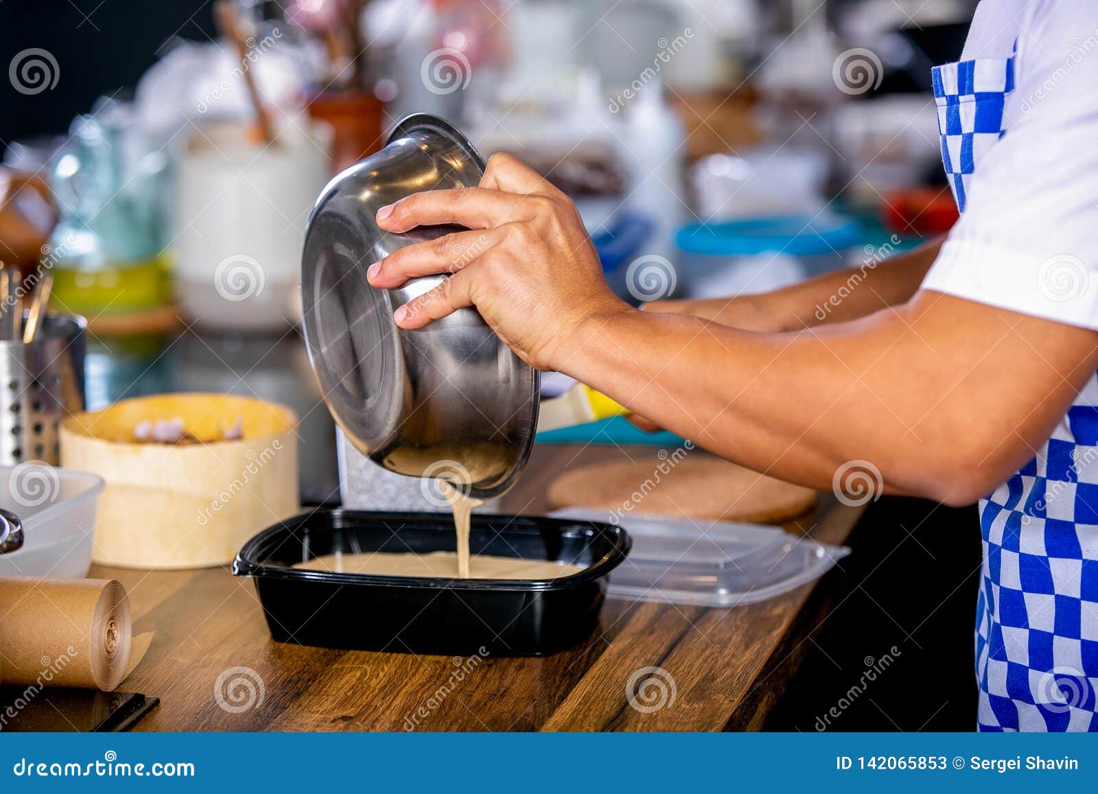 The Cook Pours the Batter Out of the Bowl into a Baking Dish. Master ...