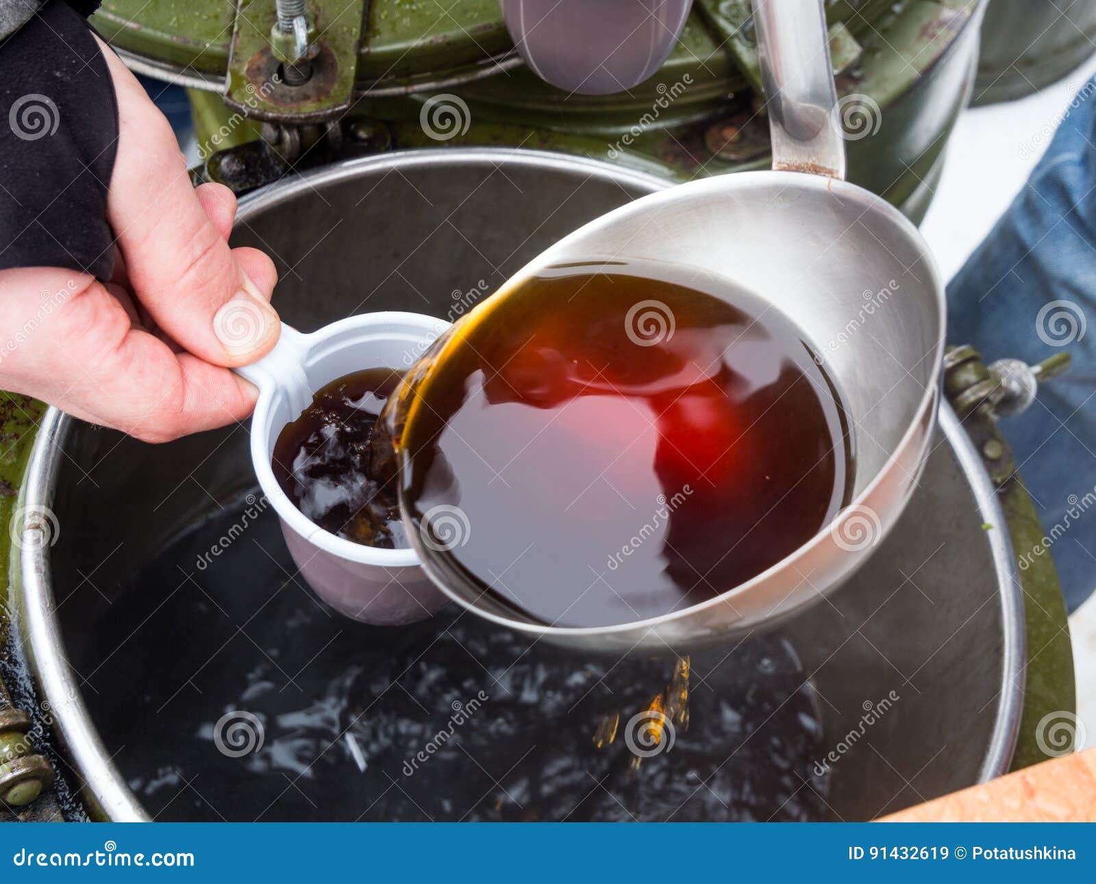 The Cook Pours Hot Tea from an Army Cauldron into a Plastic Cup Stock ...