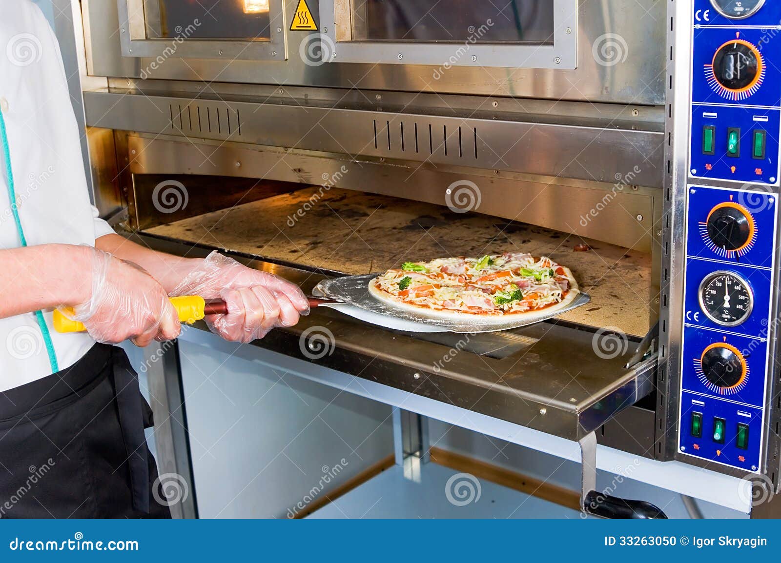 The Cook Pulls Out a Ready Pizza from the Furnace Stock Photo - Image ...