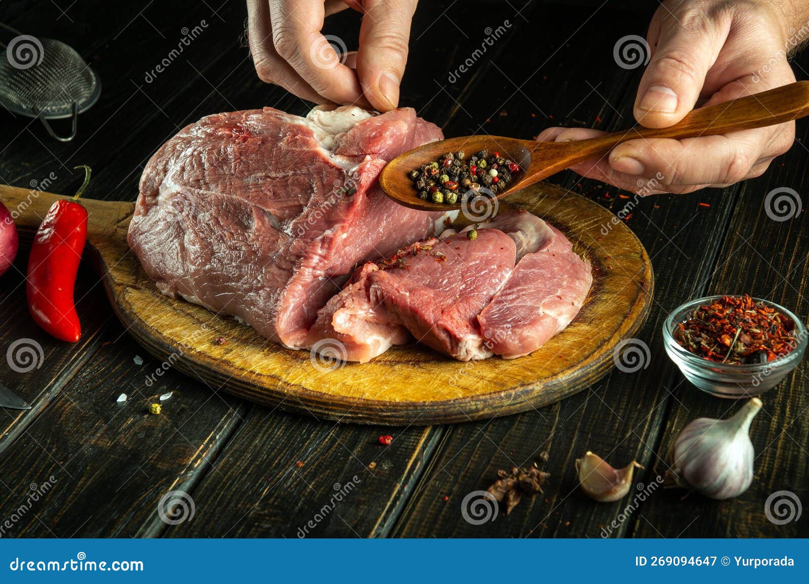 Cook S Hand with a Spoon Sprinkles Raw Meat with Dry Pepper. Preparing ...