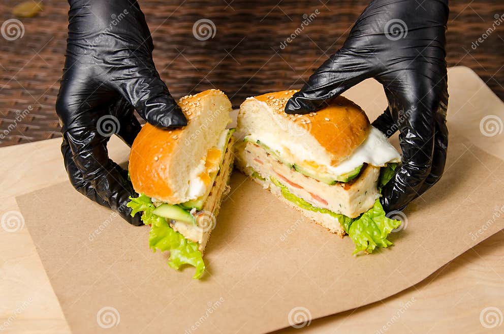 The Cook Shows the Middle of the Cut Chicken Burger Stock Photo - Image ...