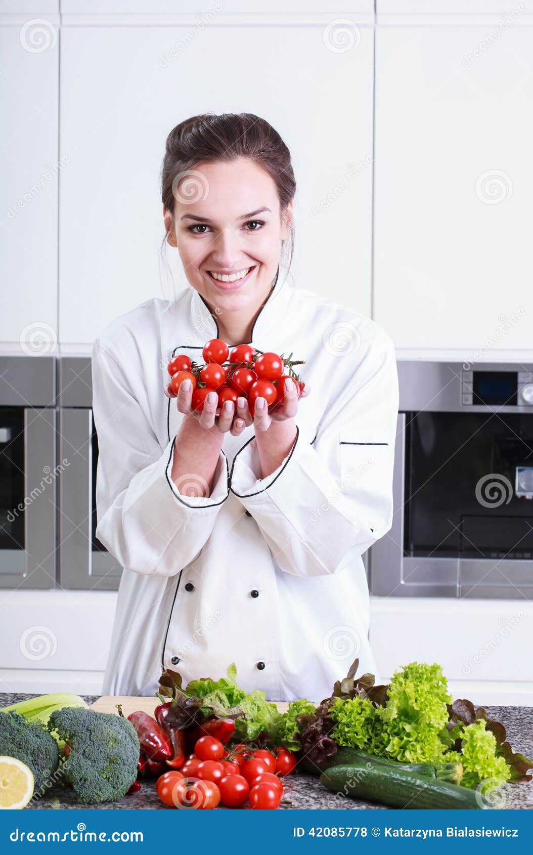 Cook shows small tomatoes stock photo. Image of delicious - 42085778