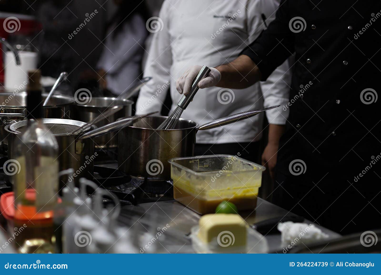 A Cook Stirring Pots in the Kitchen. Big Pots in the Kitchen Stock ...