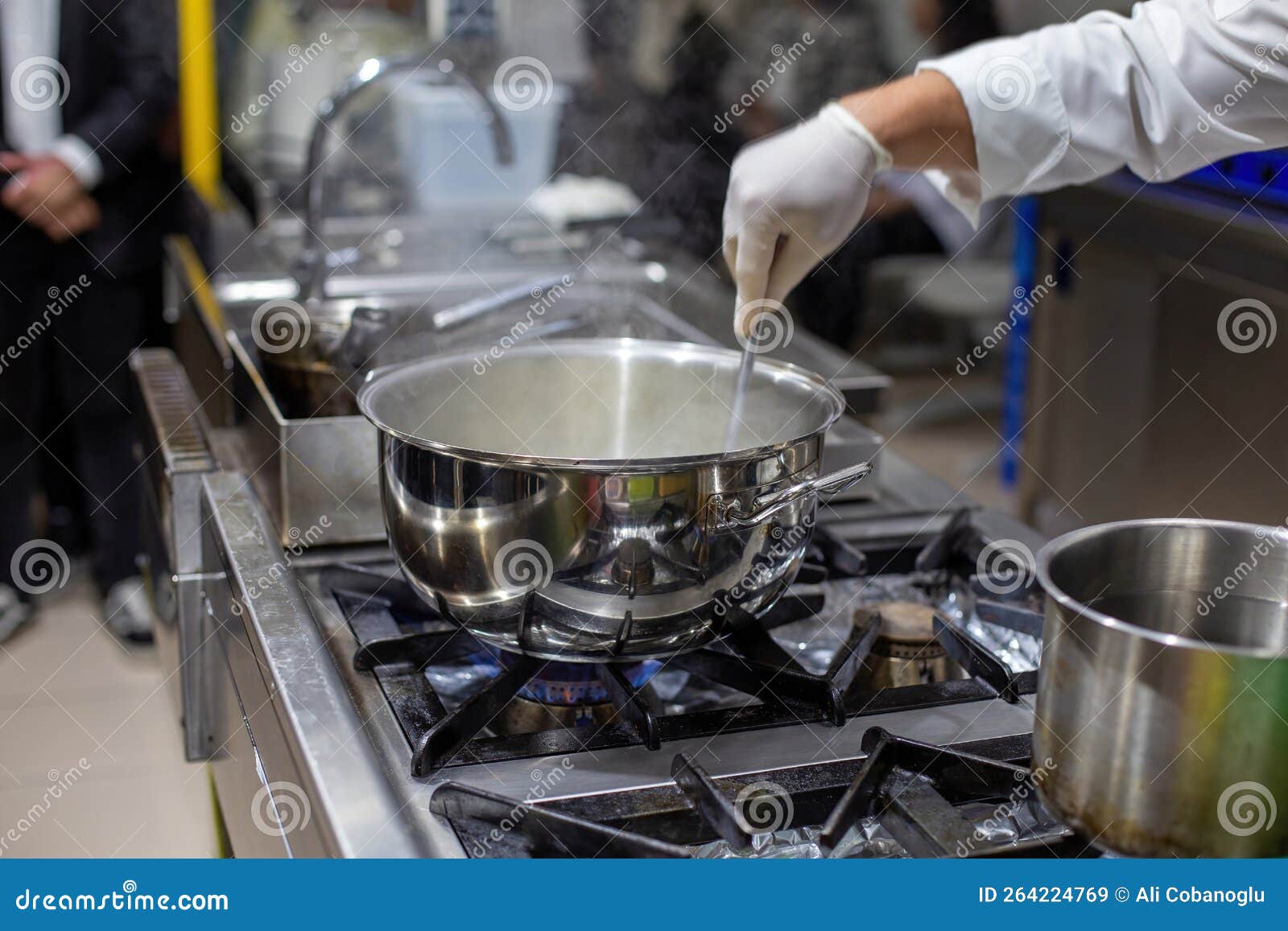 A Cook Stirring Pots in the Kitchen. Big Pots in the Kitchen Stock ...