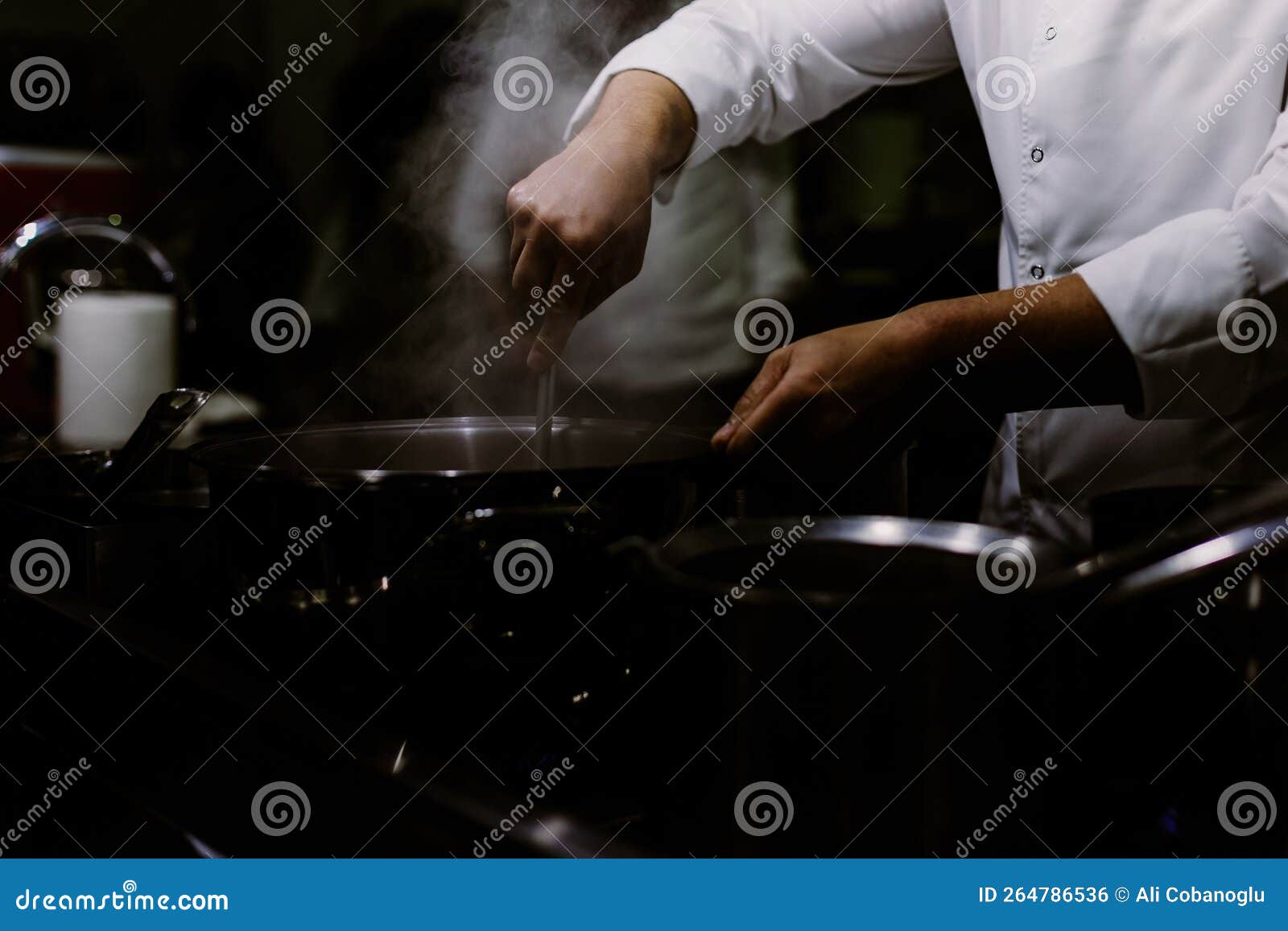 A Cook Stirring Pots in the Kitchen. Big Pots in the Kitchen. Blurry ...