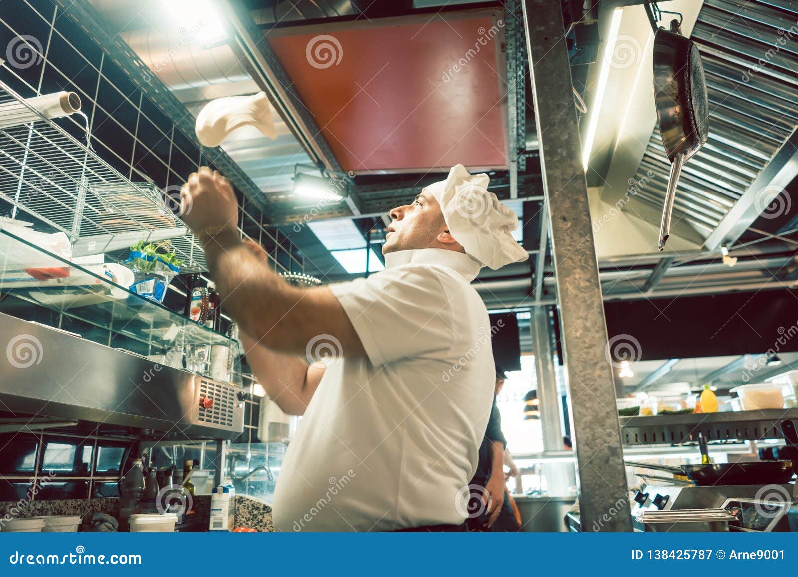 Cook Tossing Dough while Preparing Pizza in a Modern Italian Restaurant ...