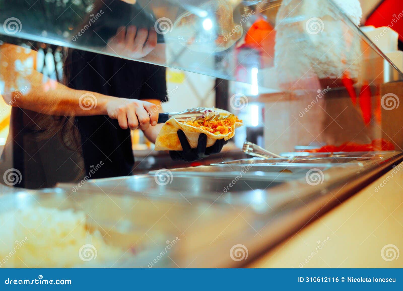 Fast Food Worker Assembling a Flat Bread Sandwich in a Restaurant Stock ...