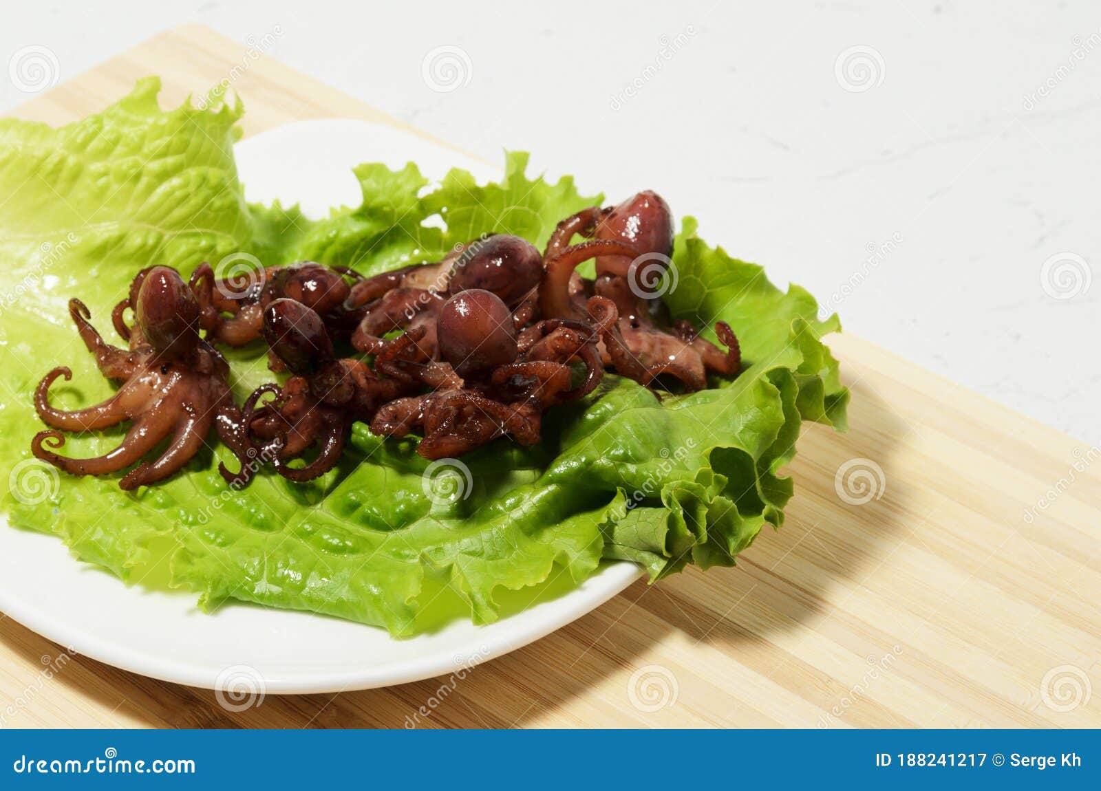 Cooked Octopuses are Placed on a Lettuce Leaf on a Plate. Bamboo ...