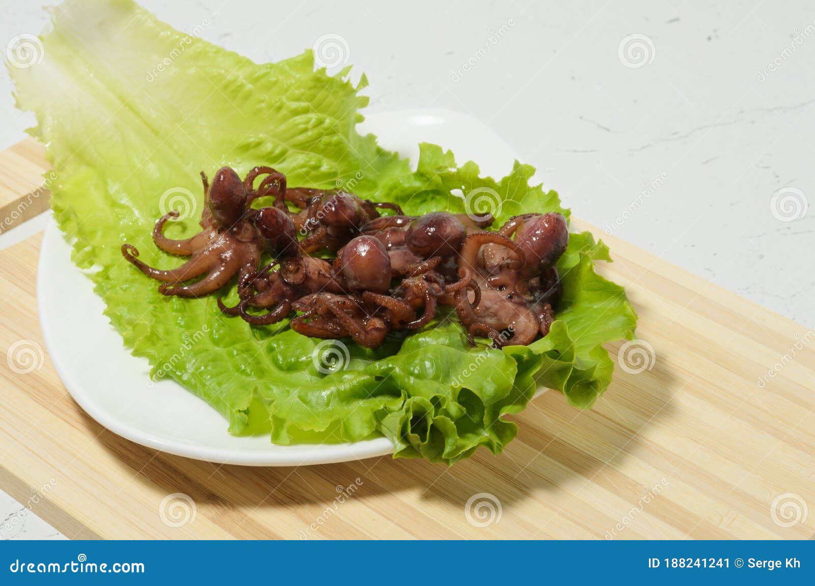 Cooked Octopuses are Placed on a Lettuce Leaf on a Plate. Bamboo ...