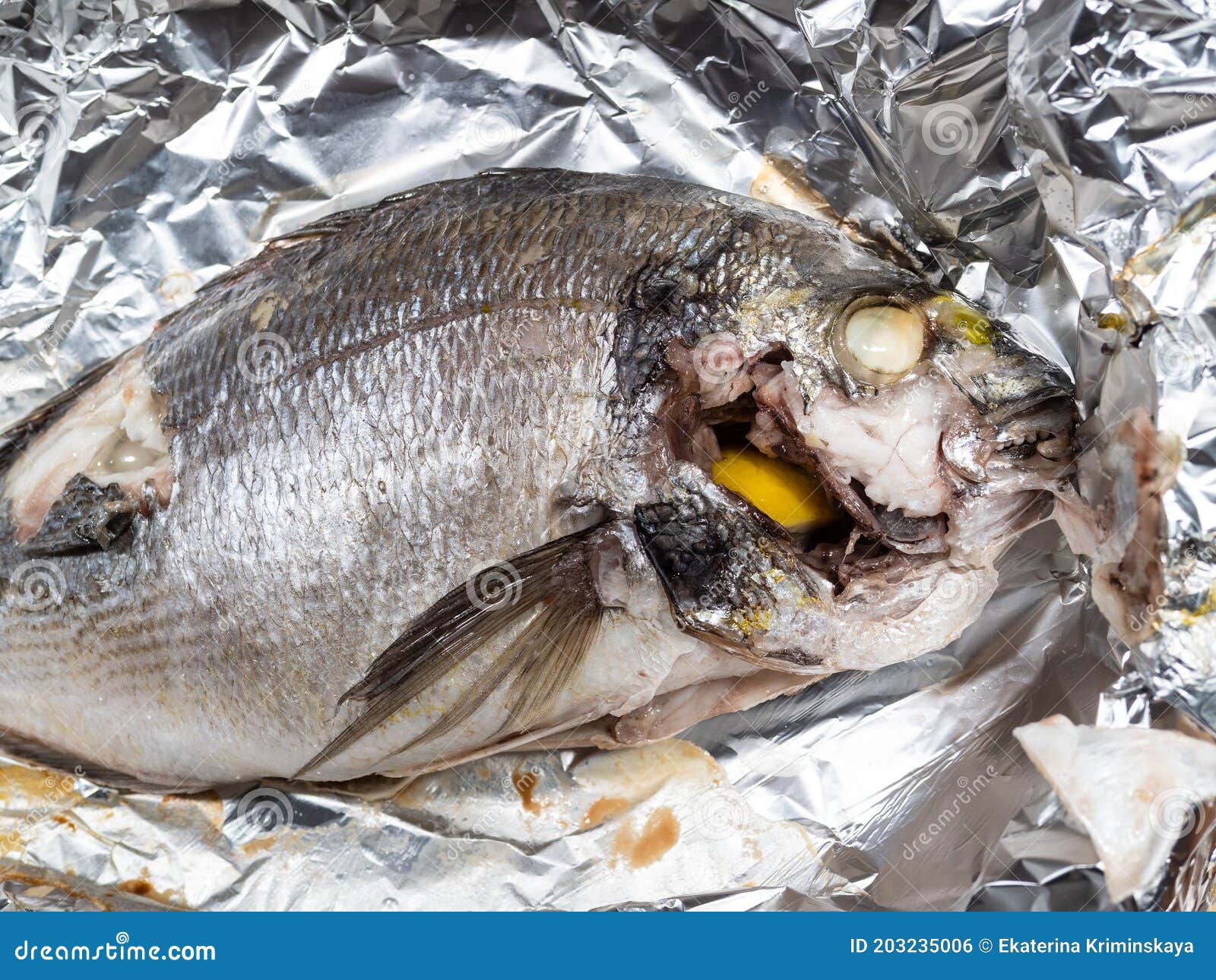 Cooked Orata Fish Stuffed by Lemon Baked in Foil Stock Photo - Image of ...