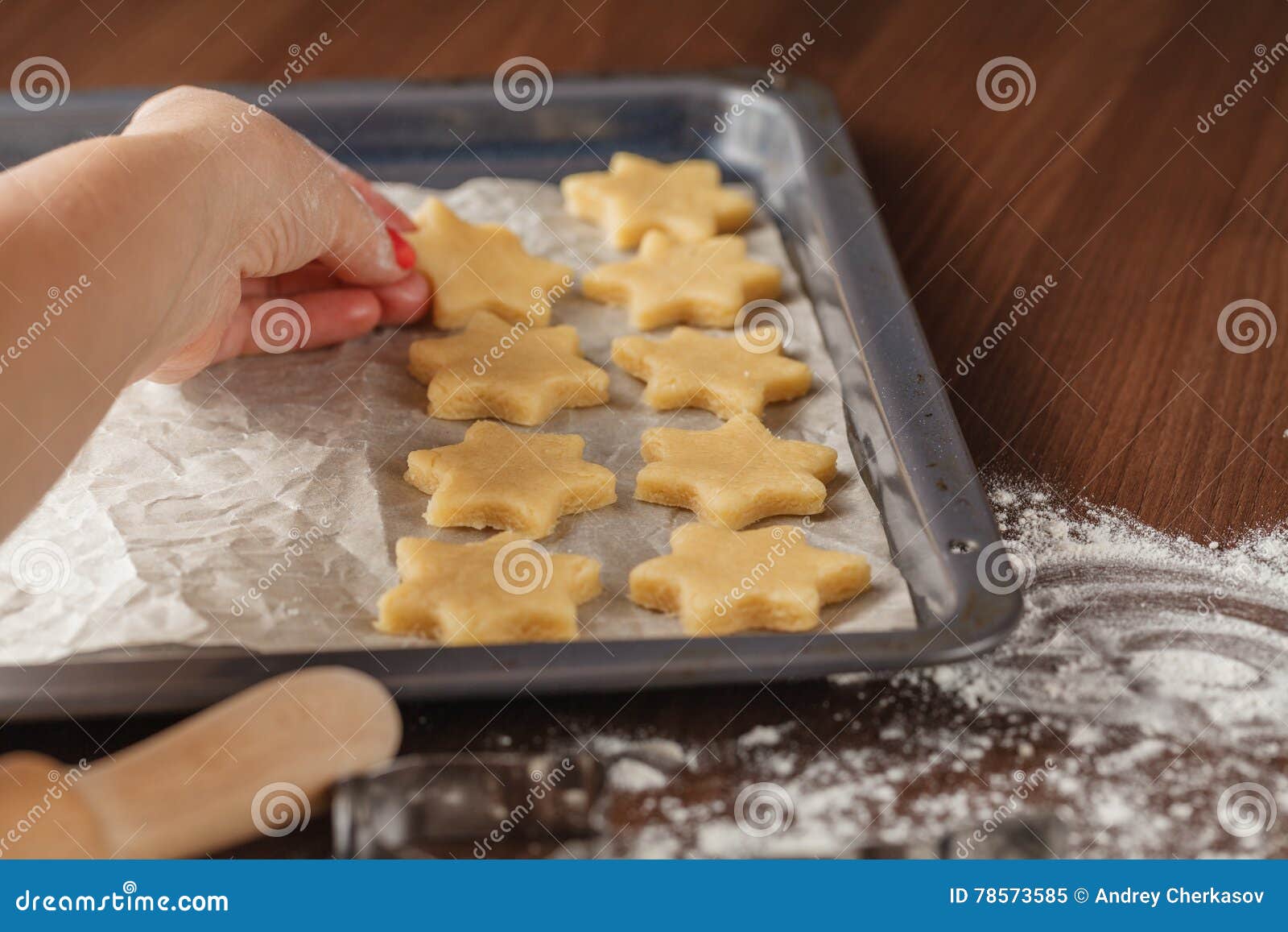 Cookie Cutters and Shortbread Shapes on a Board and a Baking Tray Stock ...