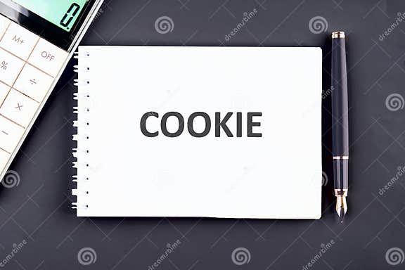 Cookie Written on Notepad Next To Calculator and Pen on Black Surface ...